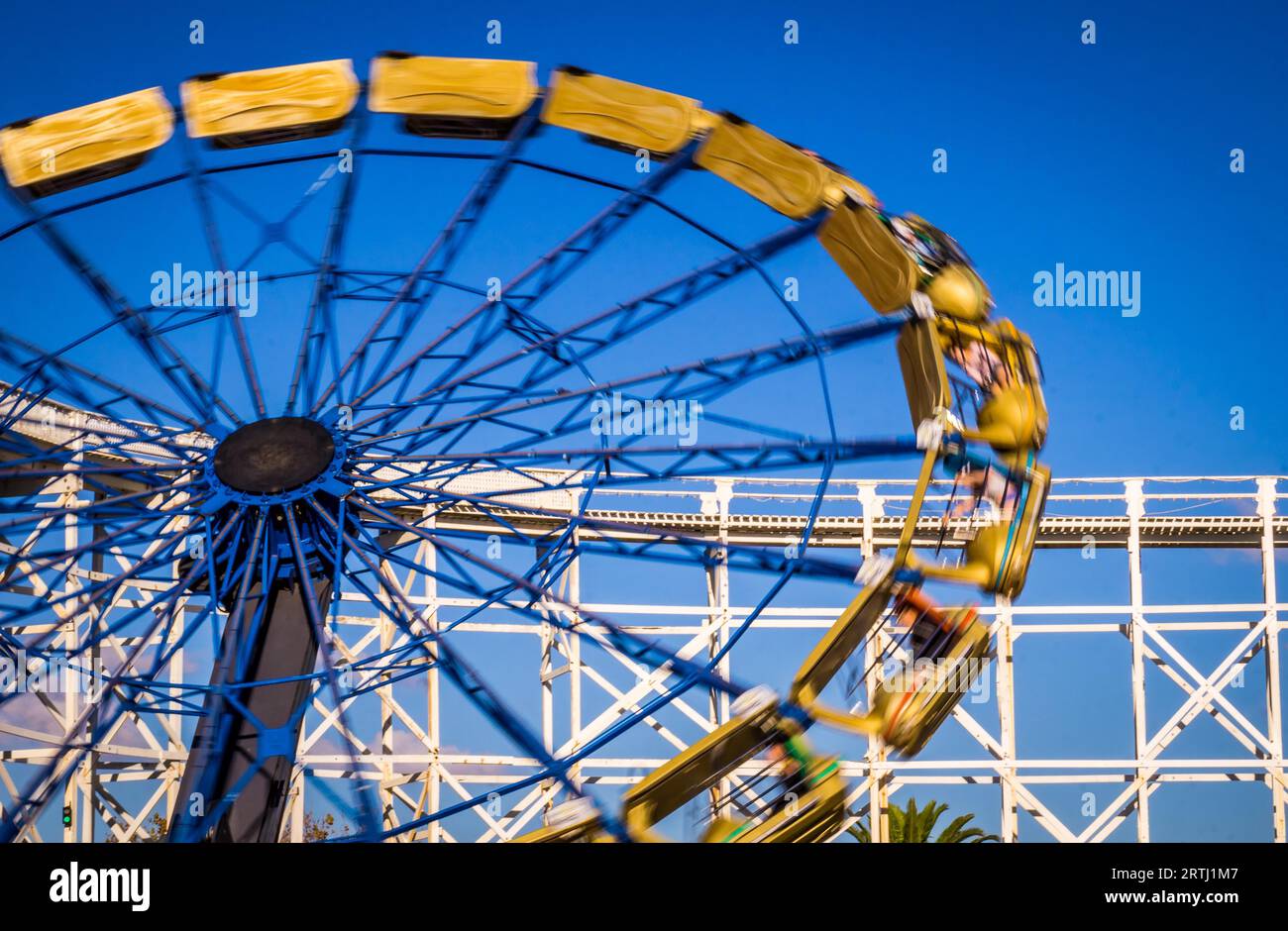 At an amusement park a Giant Wheel is moving rapidly Stock Photo - Alamy