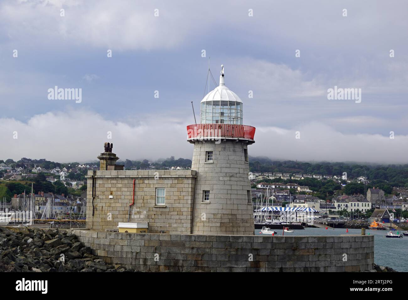 The lighthouse guards the entrance to the port of Howth Stock Photo - Alamy