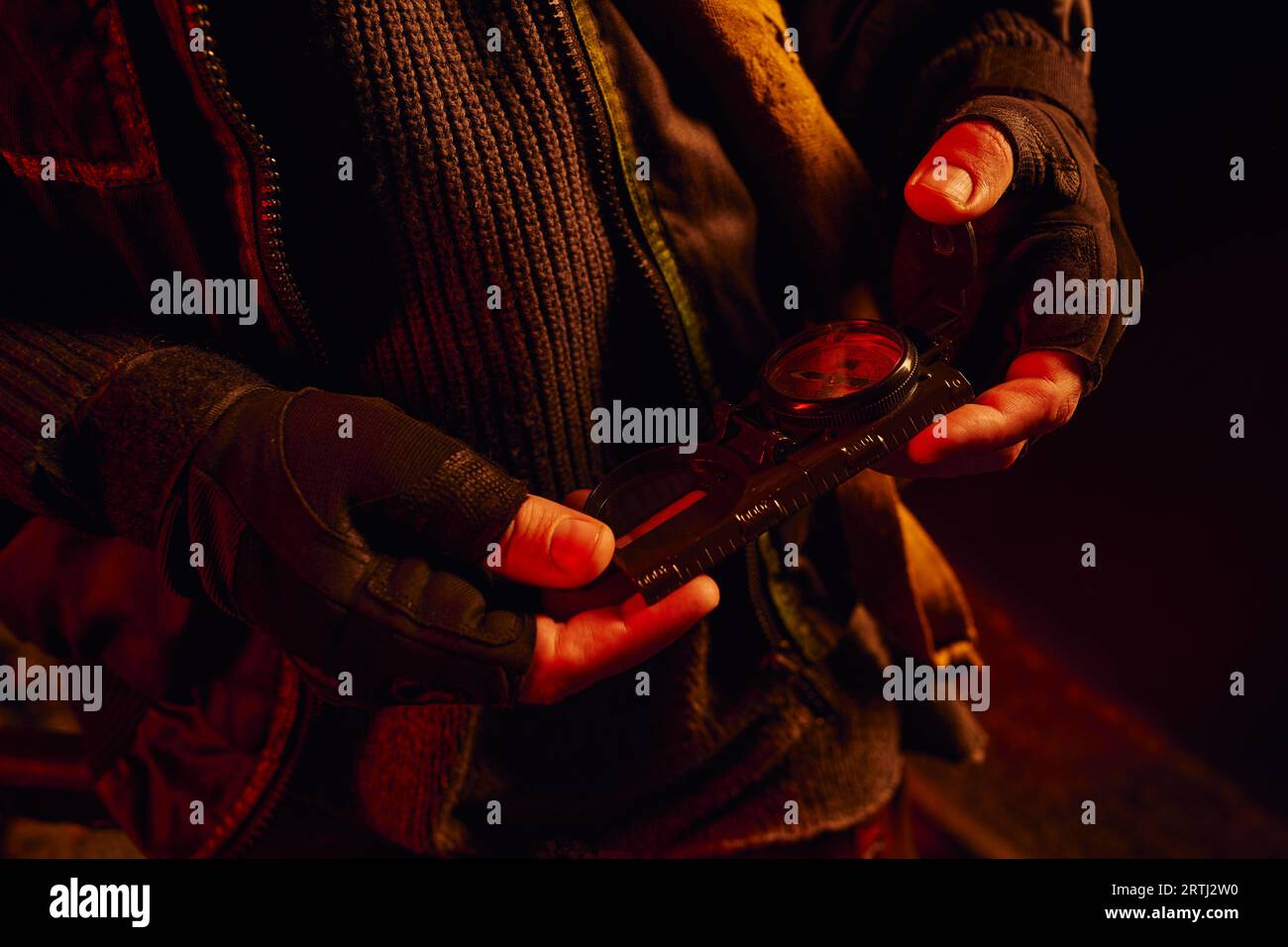 partial view of man in fingerless gloves with pressure gauge of ...