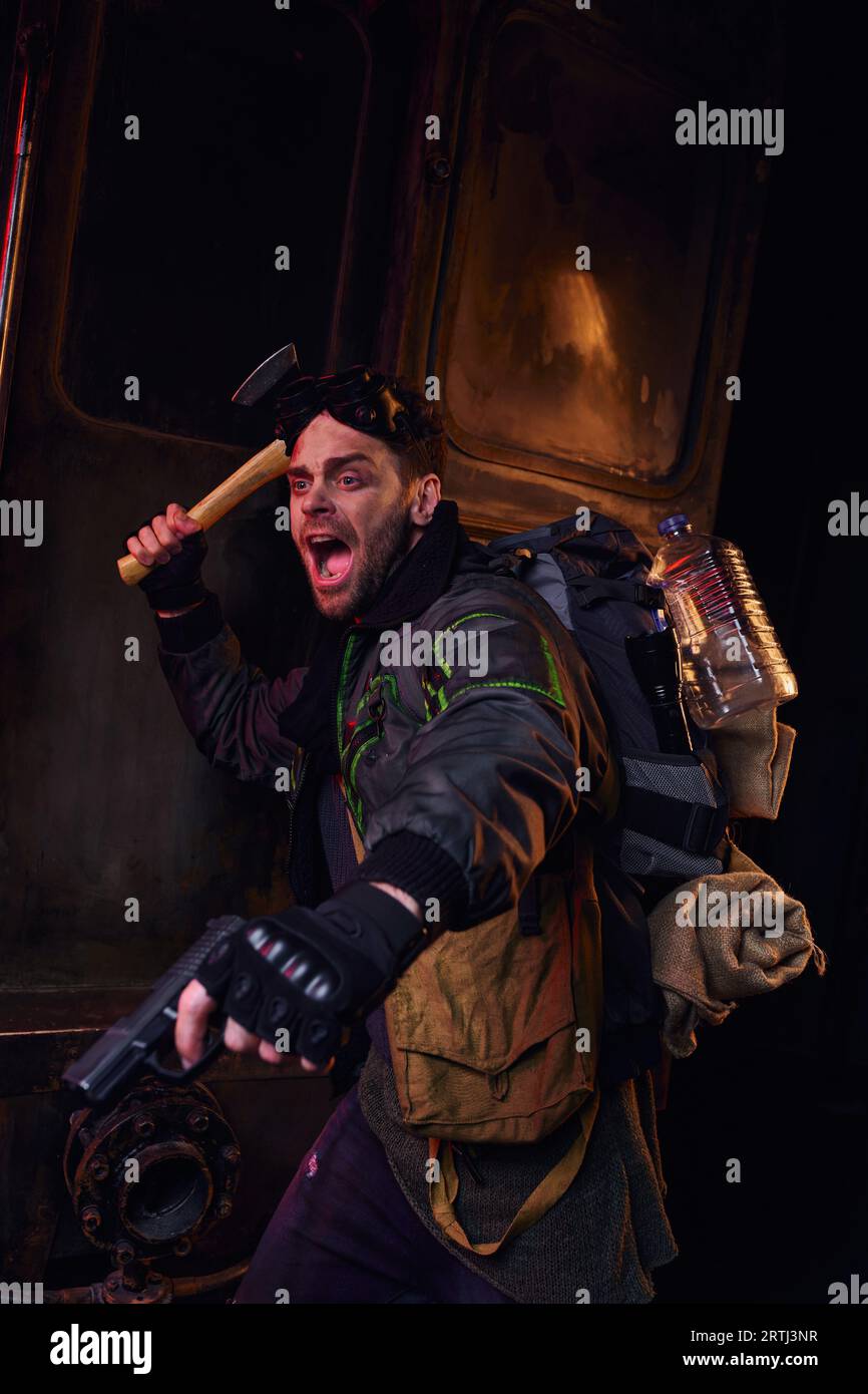 screaming man armed with axe and gun defending in abandoned subway ...