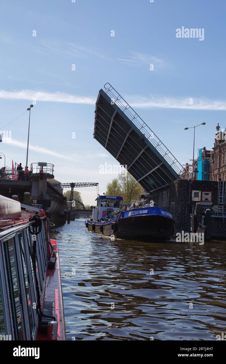 Ship passing under an open drawbridge in Amsterdam, Netherlands in ...