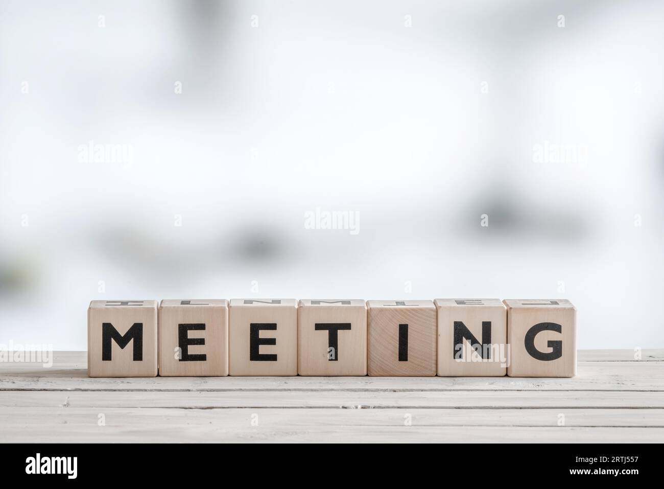 Meeting sign with wooden blocks on an office desk Stock Photo - Alamy