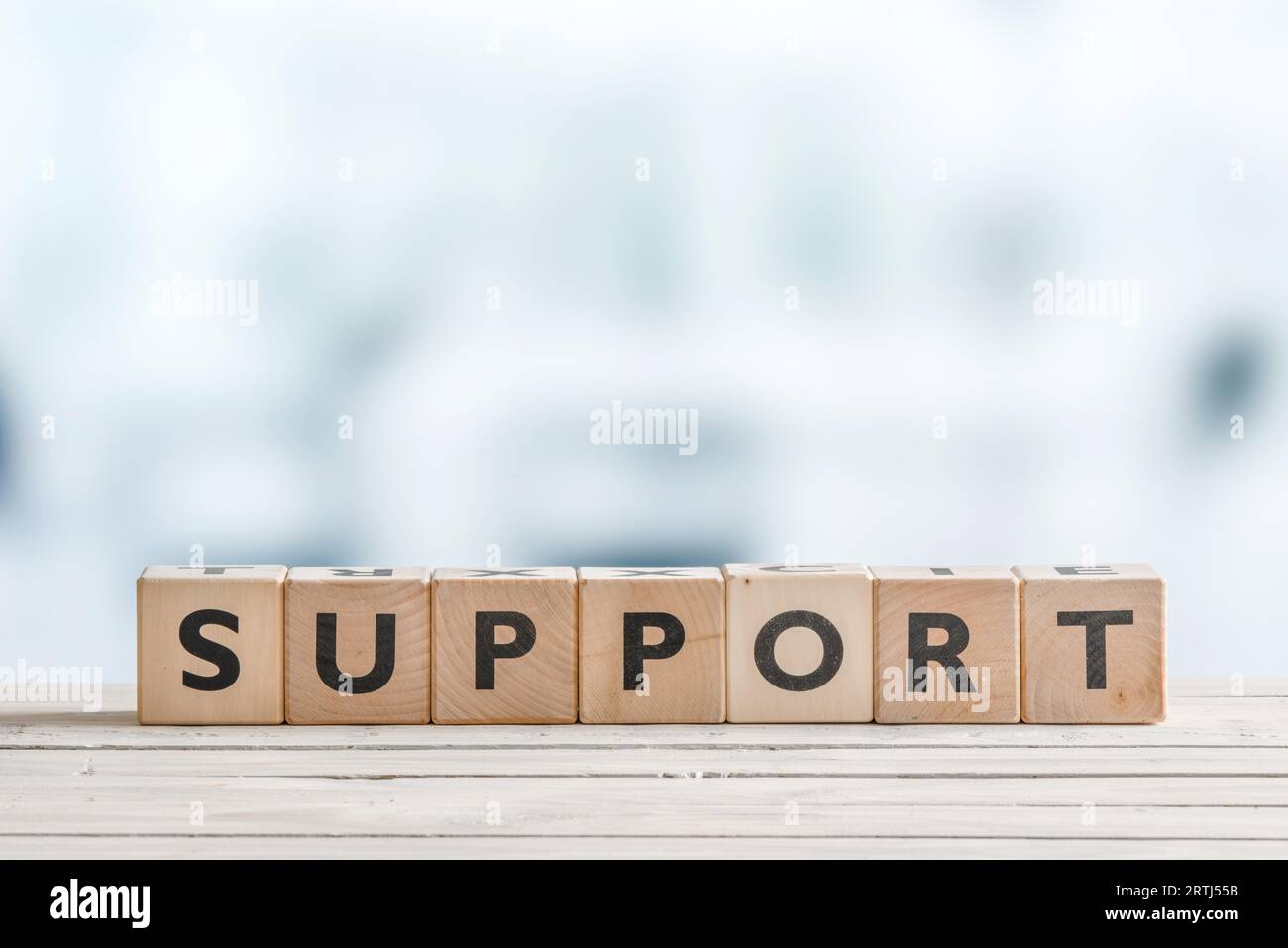 Support sign with blocks on a wooden office desk Stock Photo - Alamy