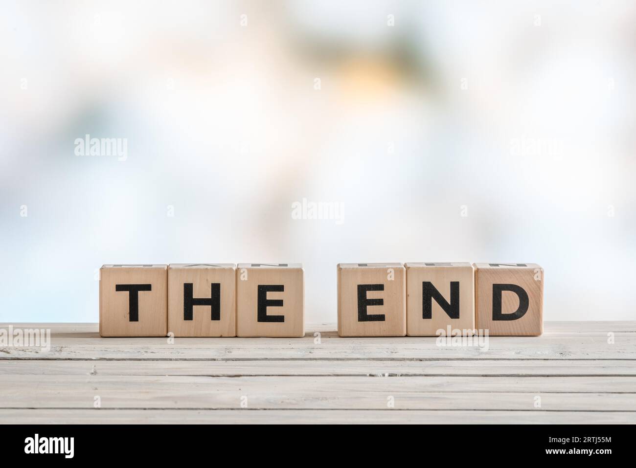 The end sign with wooden blocks on a table Stock Photo - Alamy