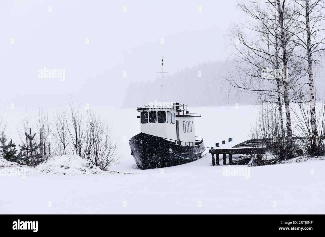 Small ship frozen in ice after halt of navigation till end of winter ...