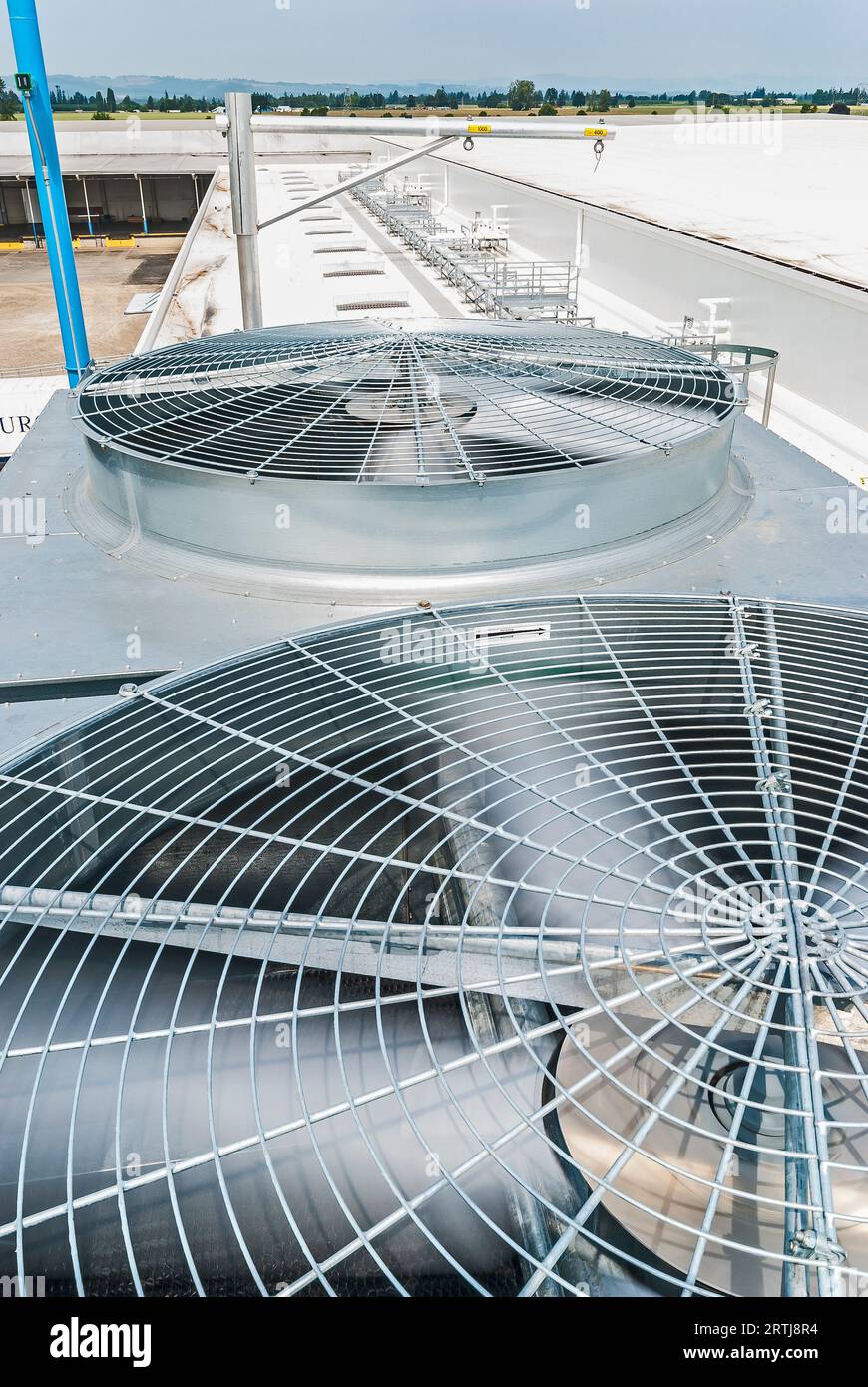 Commercial refrigeration condenser top cooling fans on roof of a cold ...