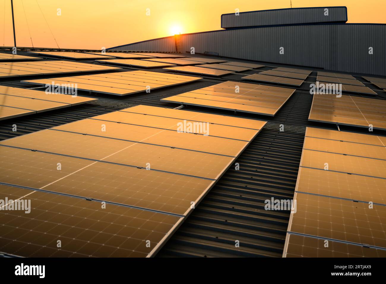 Photovoltaic solar panels on rooftop with sunset at solar cell farm ...