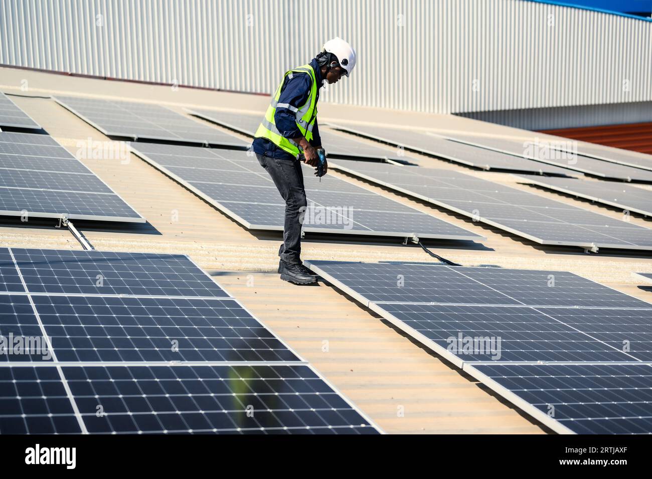 Engineers with safety helmet checking solar system at solar power farm ...