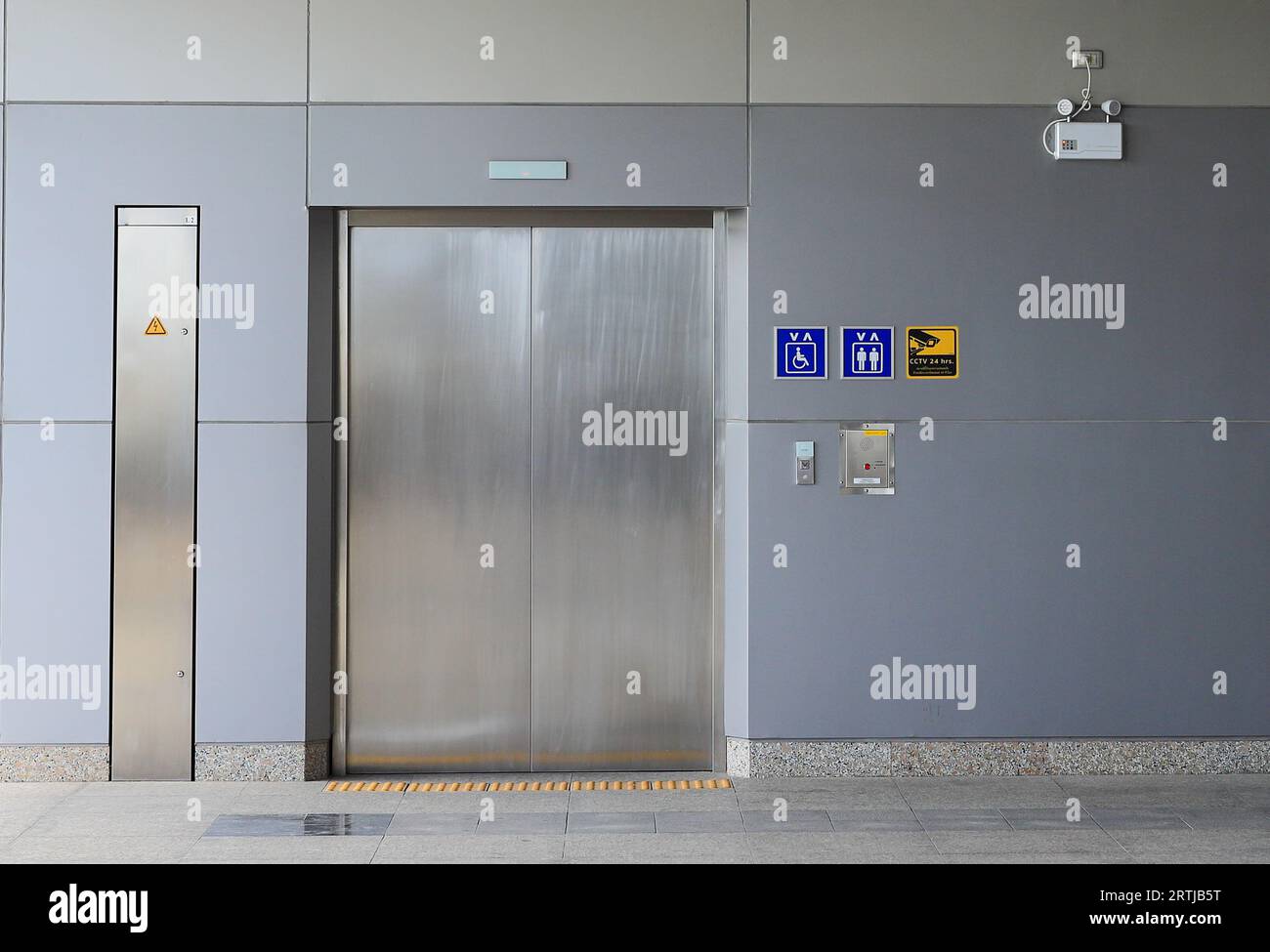 Hallway with LCD screen floor stand, Modern steel elevator cabins ...