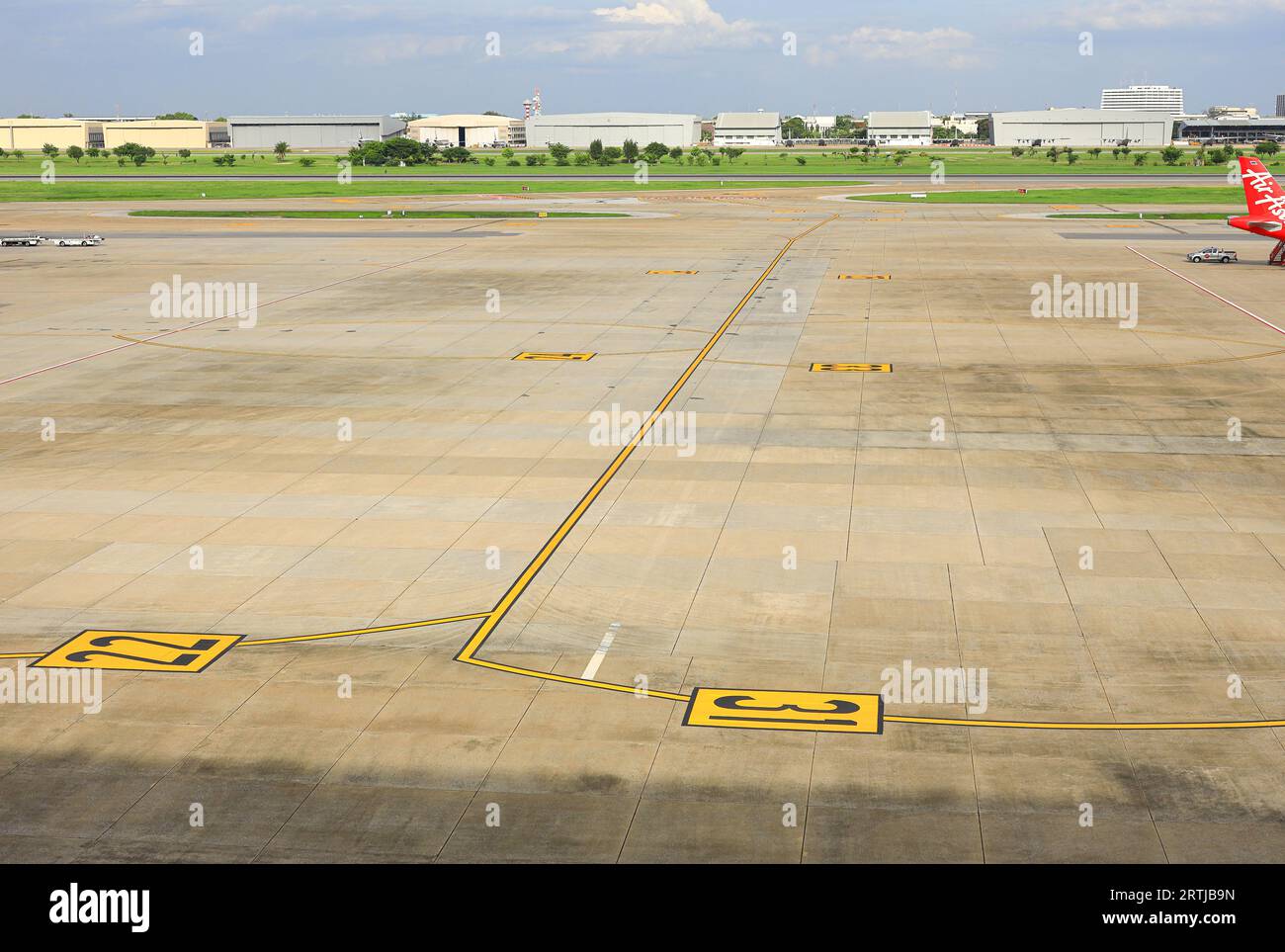 Aerial view of a commercial airport runway with marking on taxiway ...