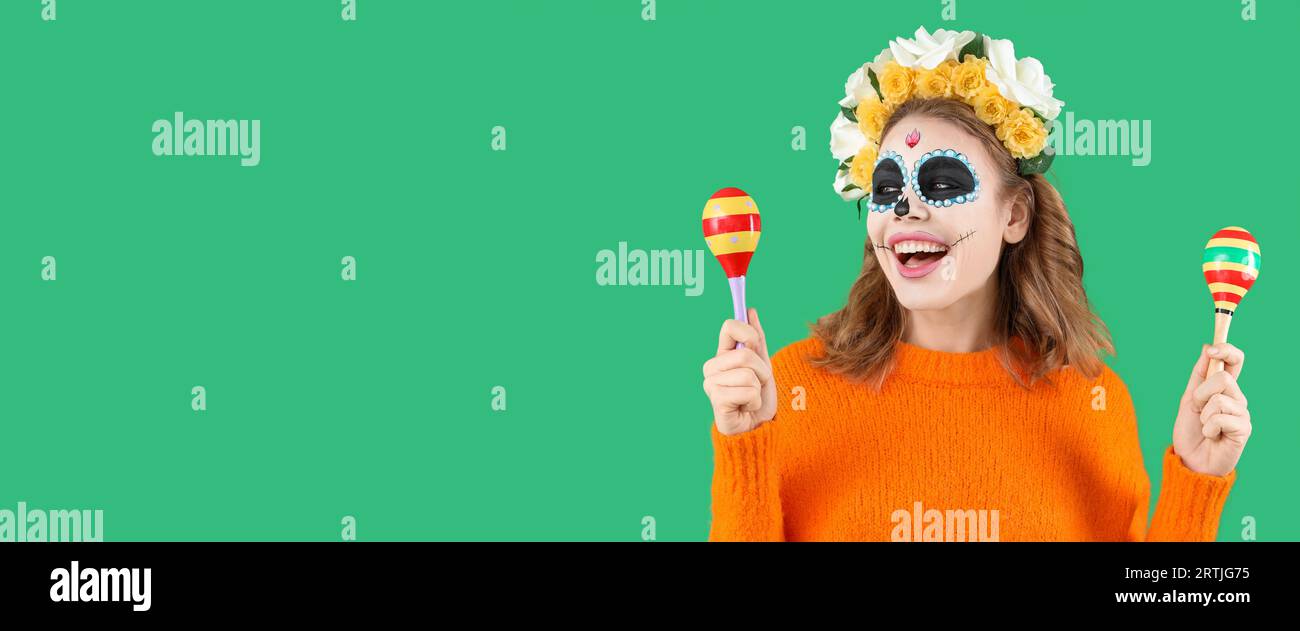 Happy woman with painted skull on face and maracas on green background ...