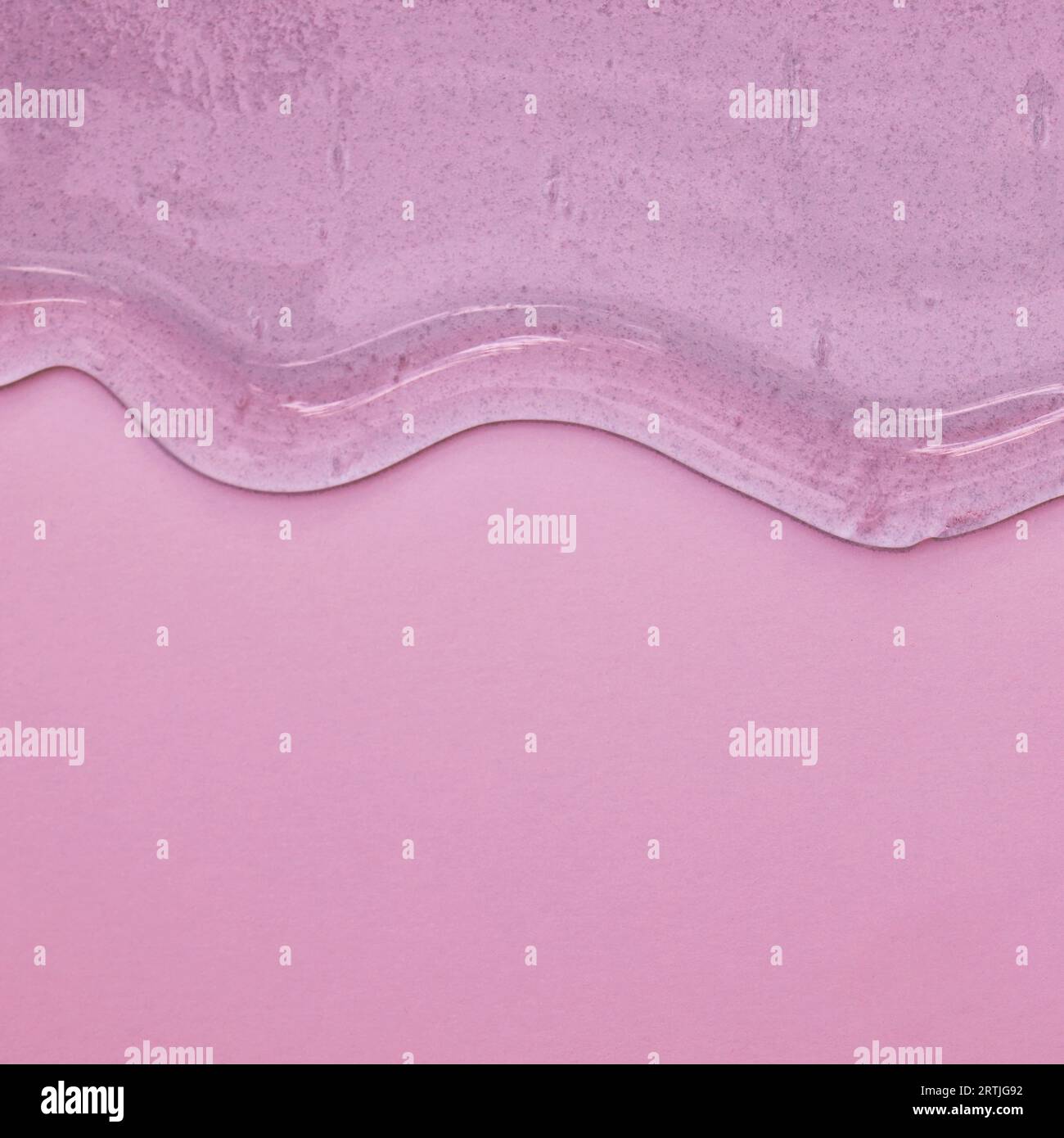 viscous pure transparent cosmetic gel on pink background. tactile , skincare, cosmetics concept ...