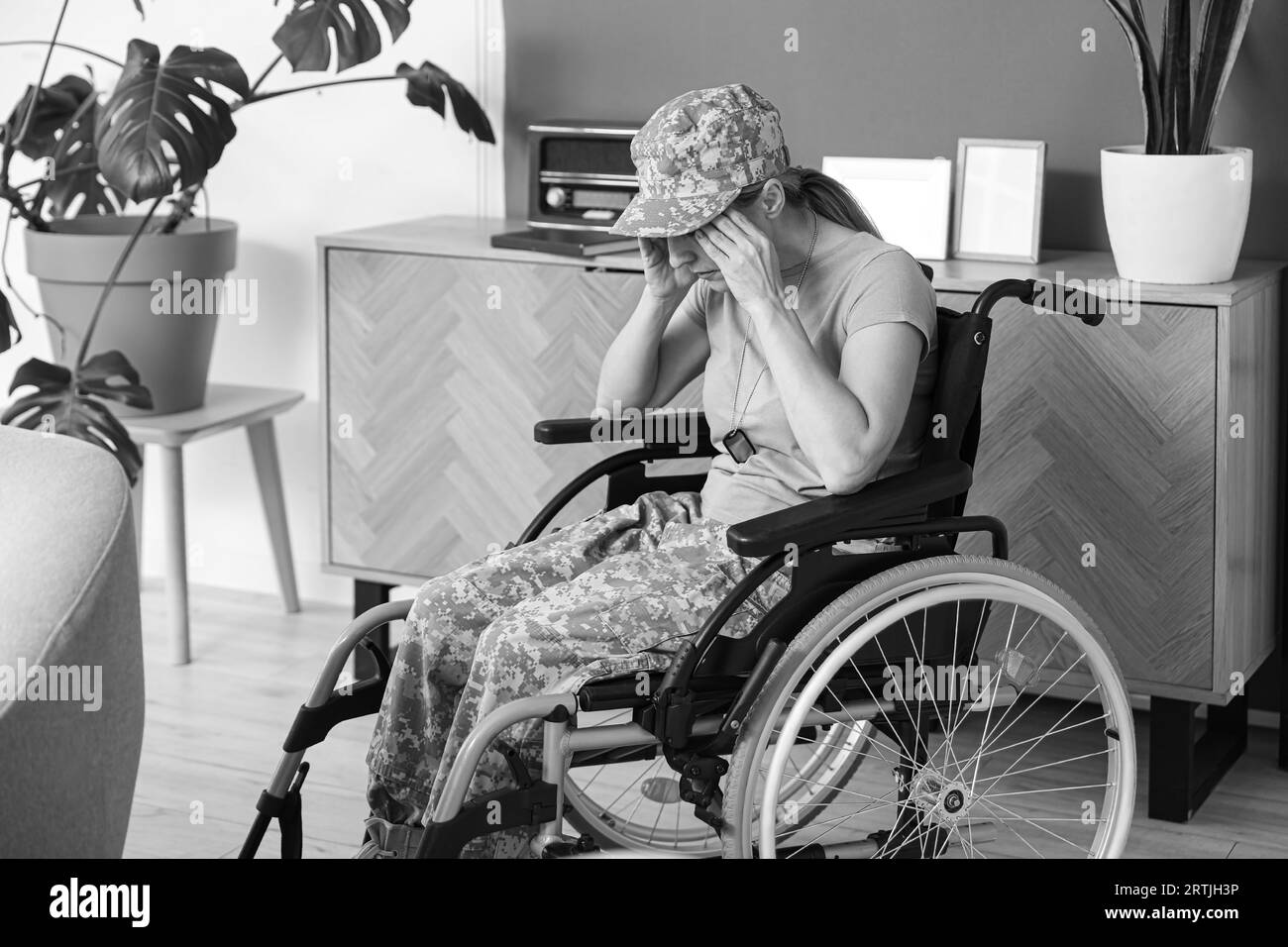 Female soldier in wheelchair with PTSD at home Stock Photo - Alamy