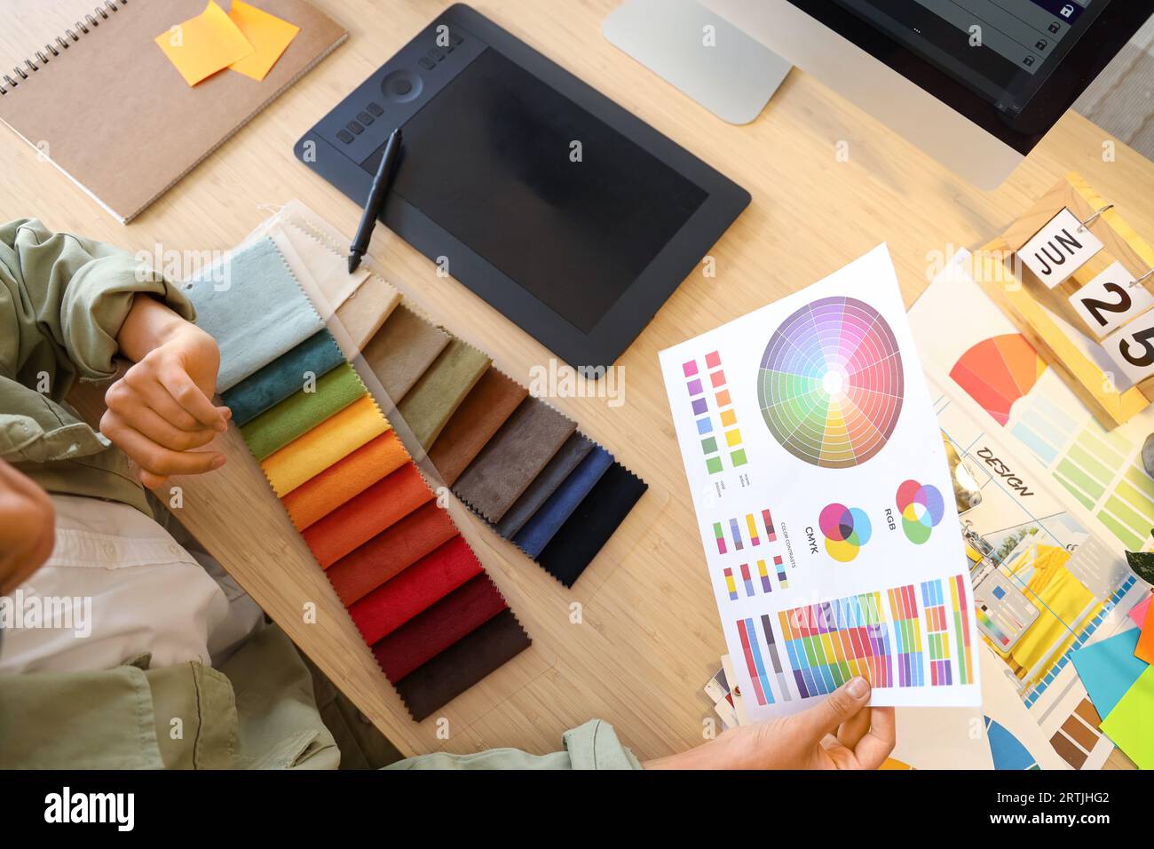 Female interior designer working with fabric samples and color palettes ...