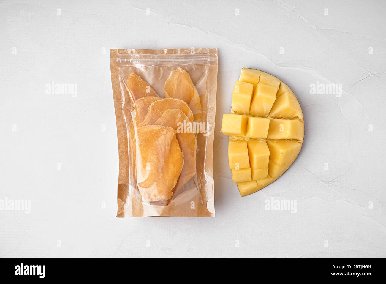 Package with slices of dried mango on white background Stock Photo - Alamy