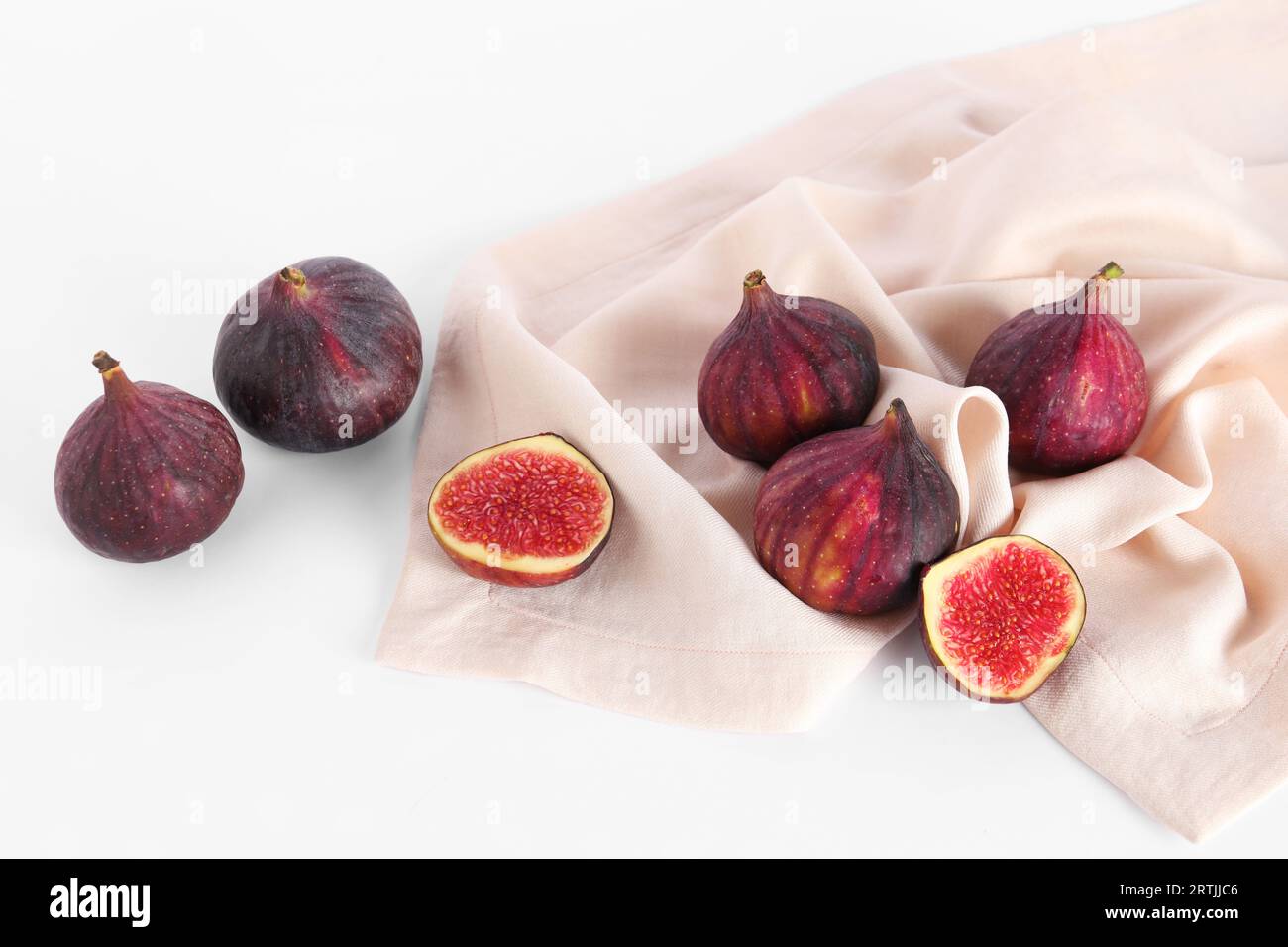 Fresh juicy cut figs isolated on white background Stock Photo - Alamy