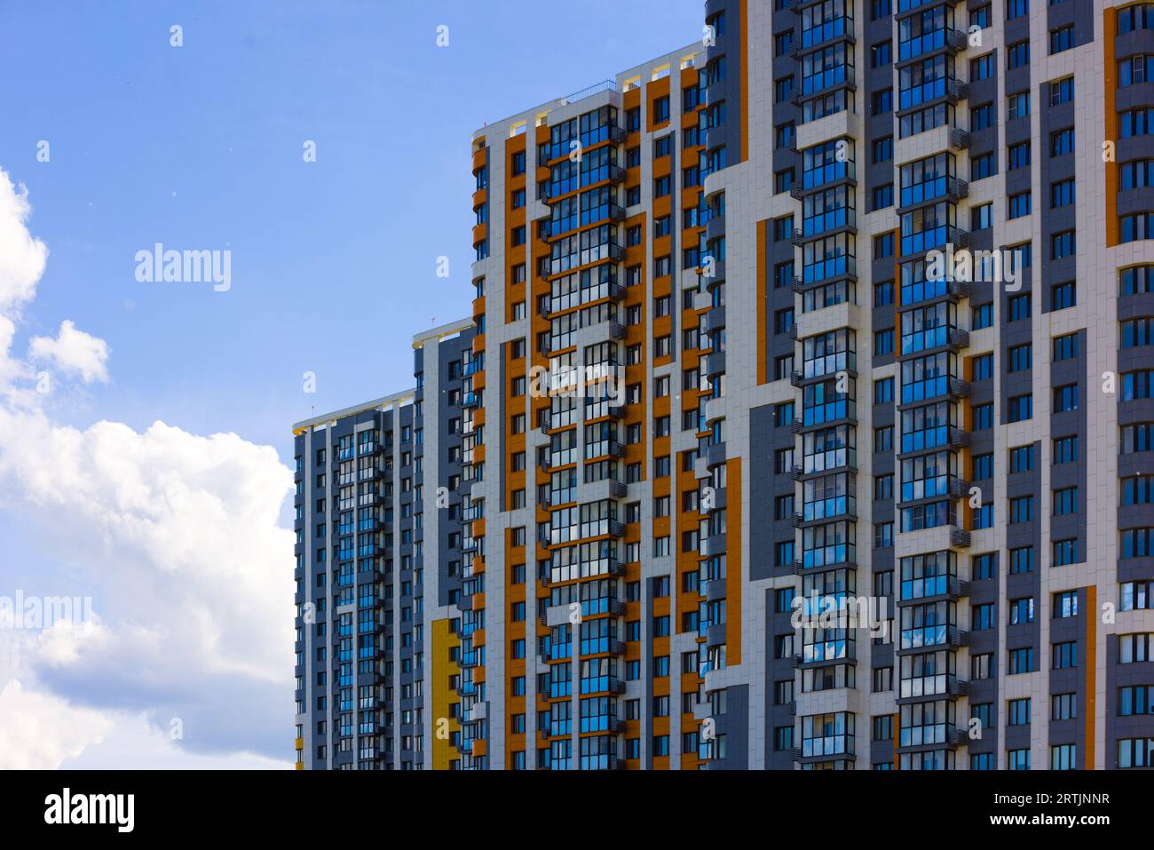 freshly built high rise apartment buildings on blue sky background with ...