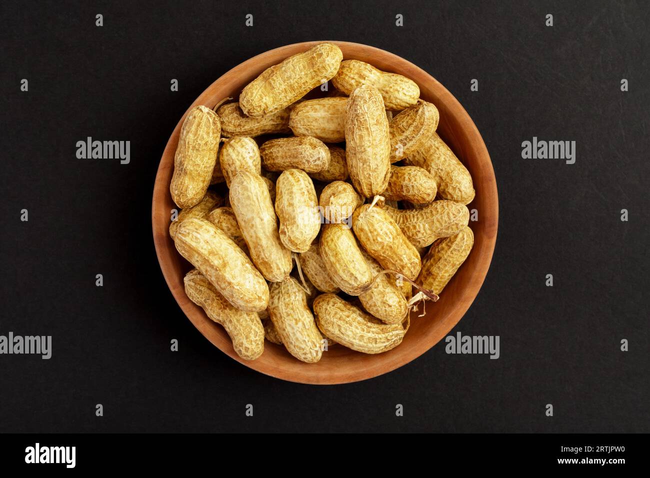 Roasted peanuts, peanuts in shell Isolated on black background Stock ...