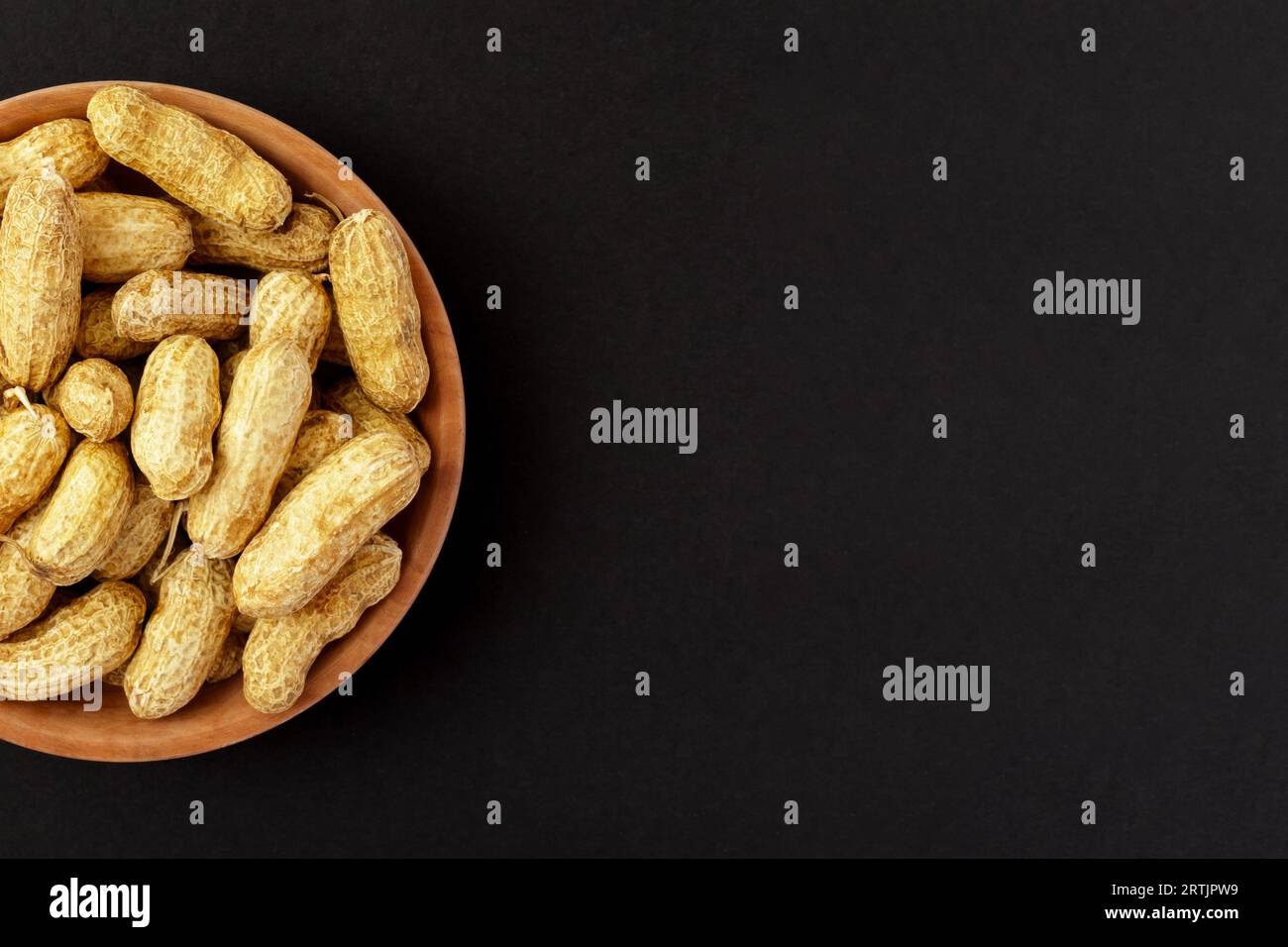 Roasted peanuts, peanuts in shell Isolated on black background Stock ...