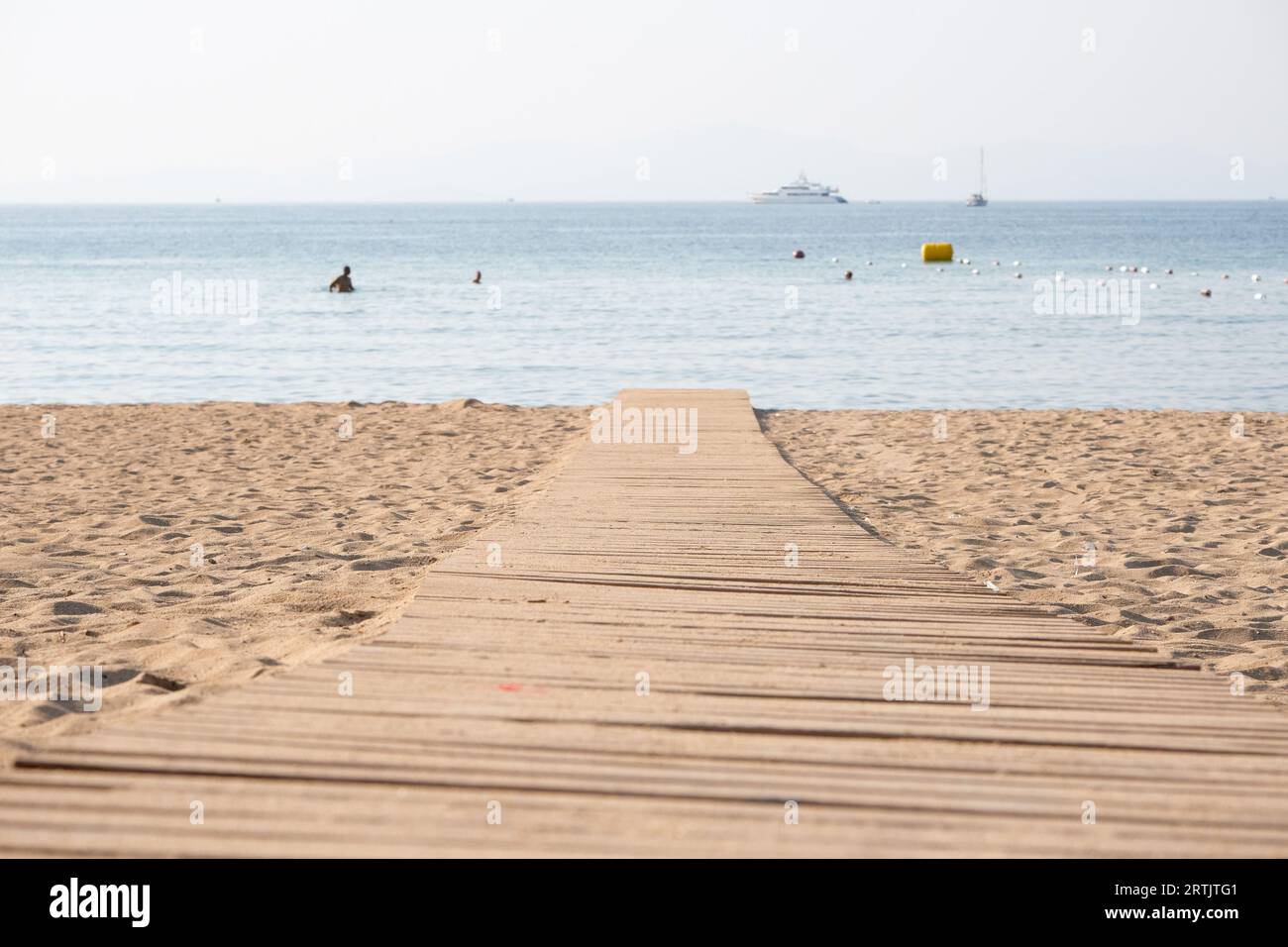 Knee ground level of sand beach wood way going to sea with sky and ...