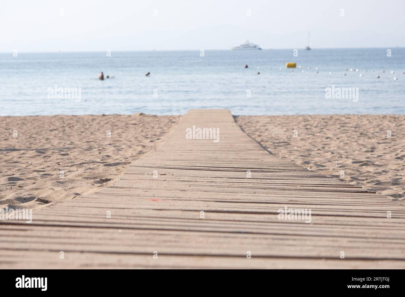 Knee ground level of sand beach wood way going to sea with sky and ...