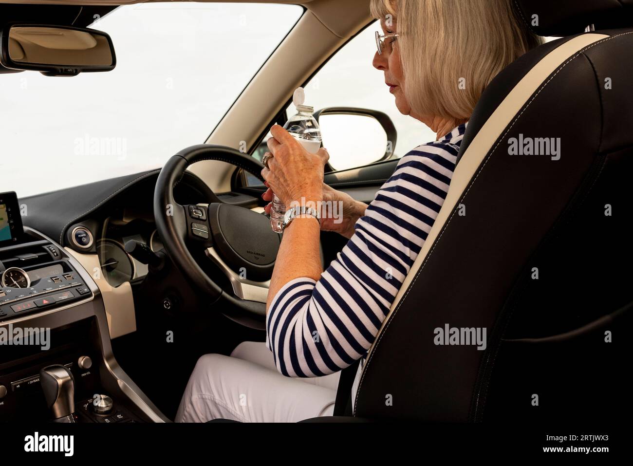 Portsmouth, England, UK. 29 August 2023. Woman driver taking a drink of ...