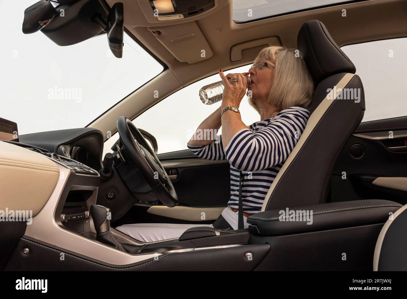 Portsmouth, England, UK. 29 August 2023. Woman driver taking a drink of ...