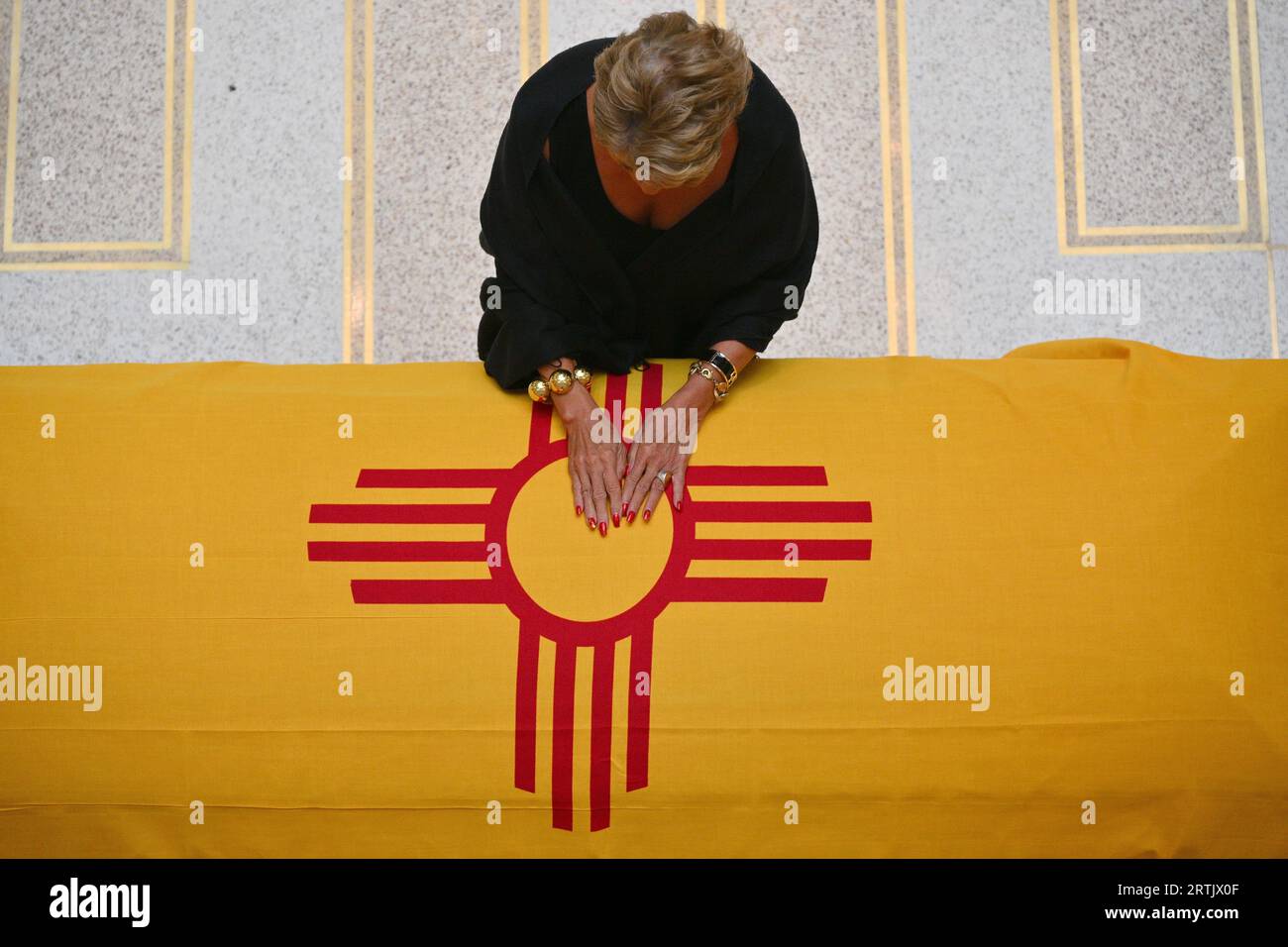 Santa Fe, United States. 13th Sep, 2023. A visitor pays her respects to ...