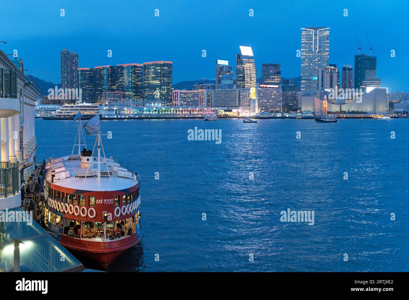 Star Ferry at night docking at Central Pier on Victoria Harbour with ...