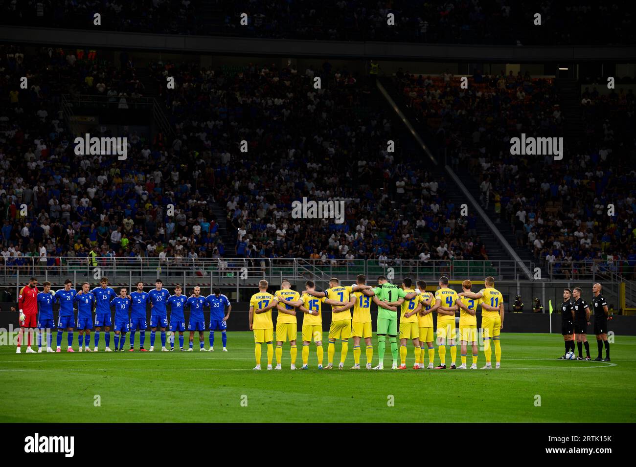 Players and officials observe a minute of silence for the victims of ...