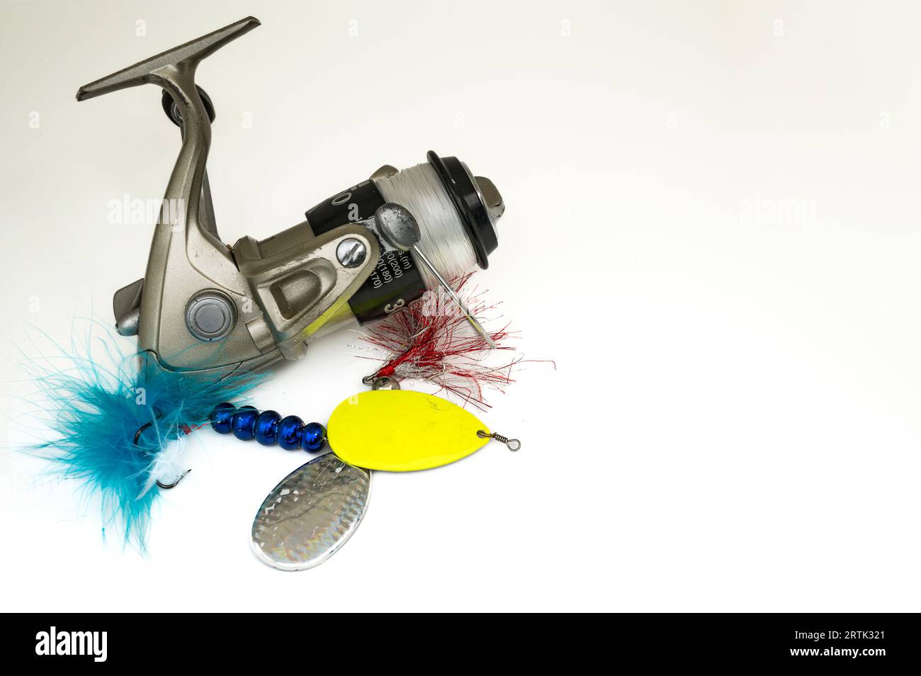 fishing wheel with a yellow lure isolated on white Stock Photo - Alamy