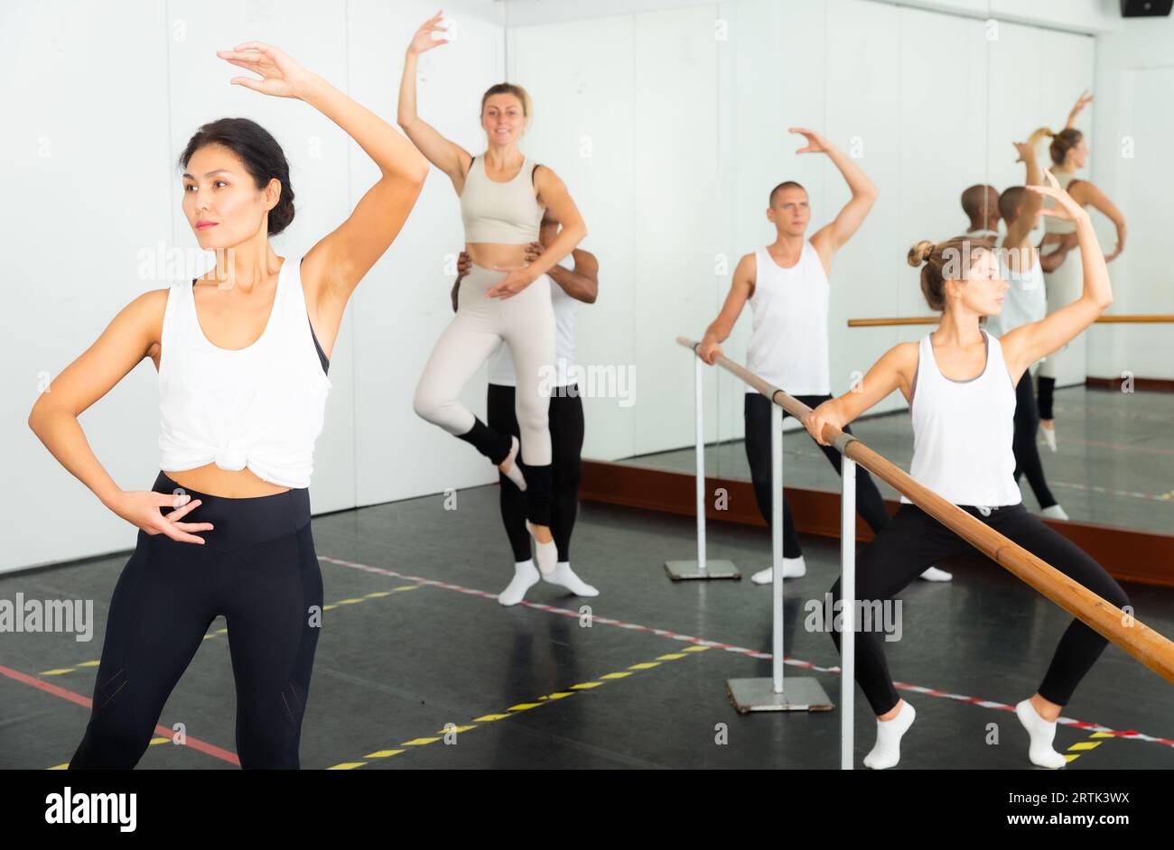 Lesson in ballet school - men and women perform ballet exercises Stock ...