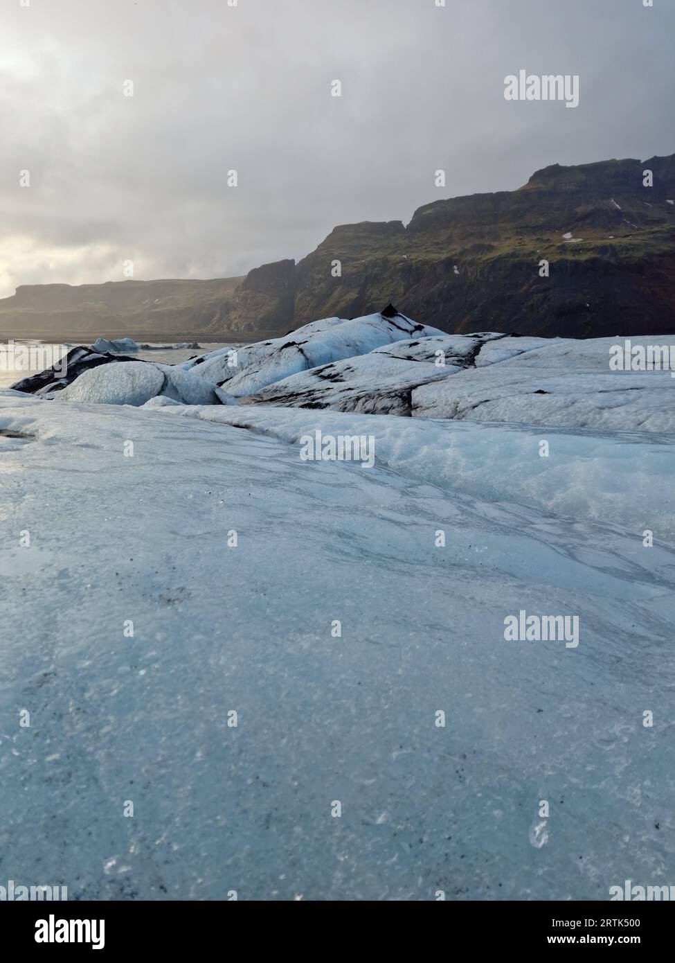Drone shot of lake with ice cap, vatnajokull glacier mass forming ...