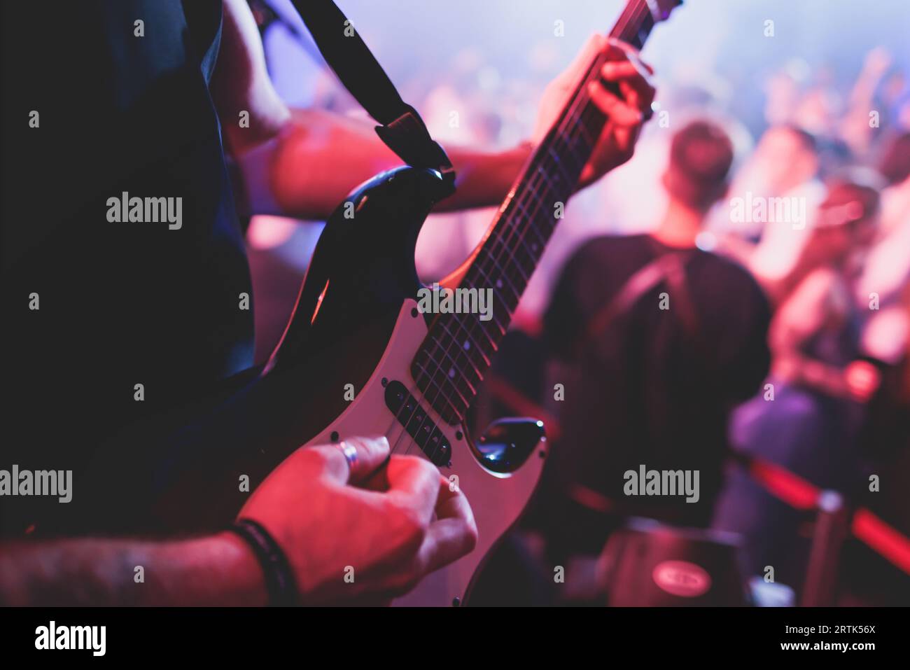 Concert view of an electric guitar player with vocalist and rock band ...