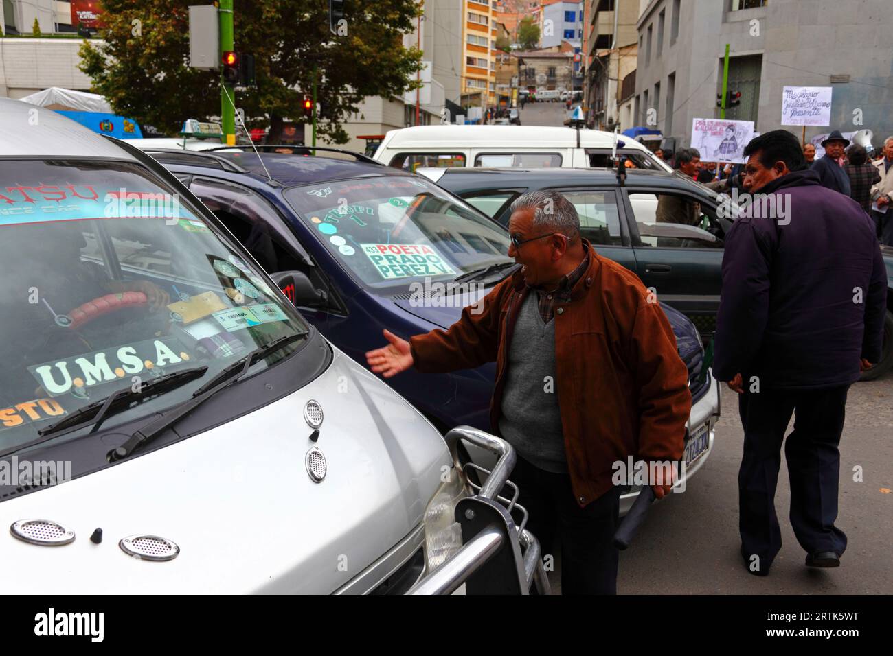A man argues with a public transport minibus driver at a road block ...