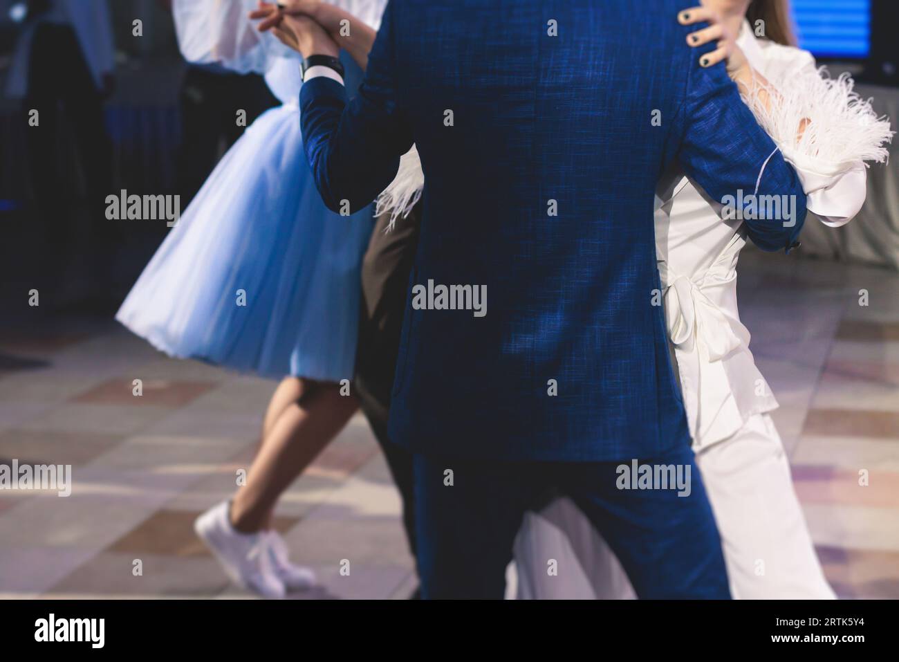 High school graduates dancing waltz and classical ball dance in dresses ...