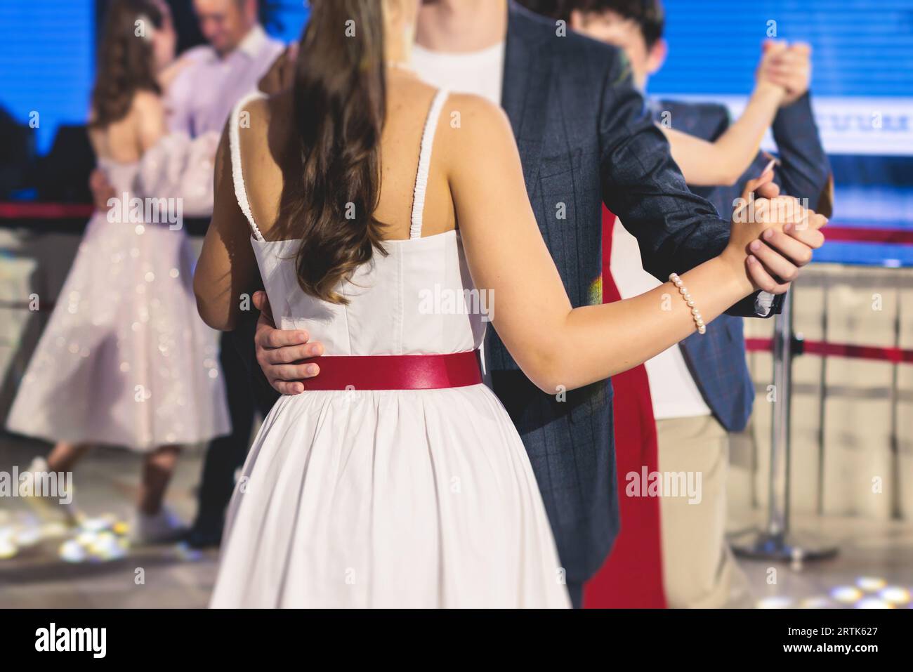 High school graduates dancing waltz and classical ball dance in dresses ...