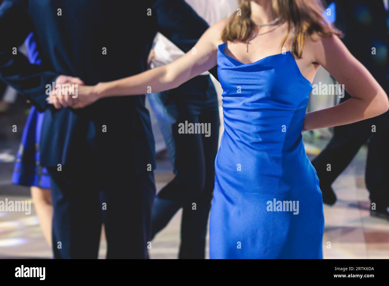 High school graduates dancing waltz and classical ball dance in dresses ...