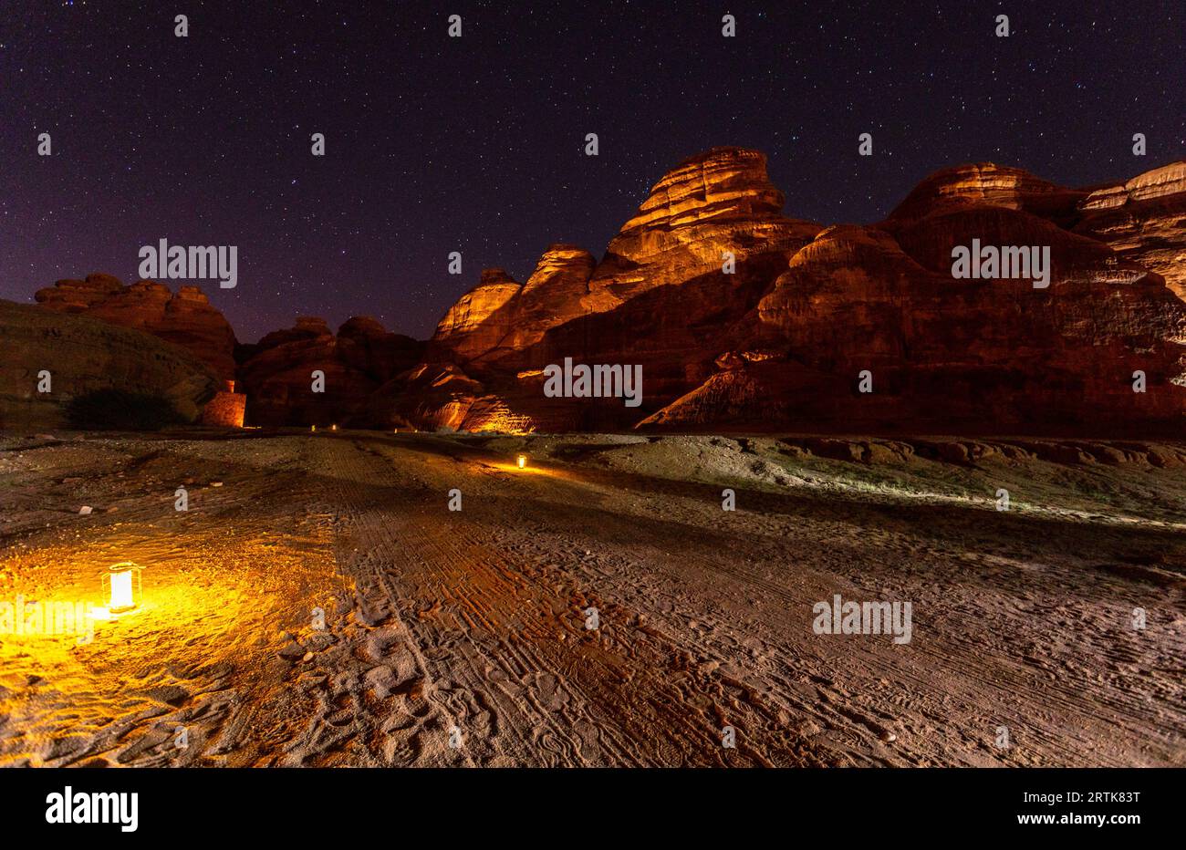 Starlight sky over illuminated desert, night panorama, Hegra, Al Ula ...