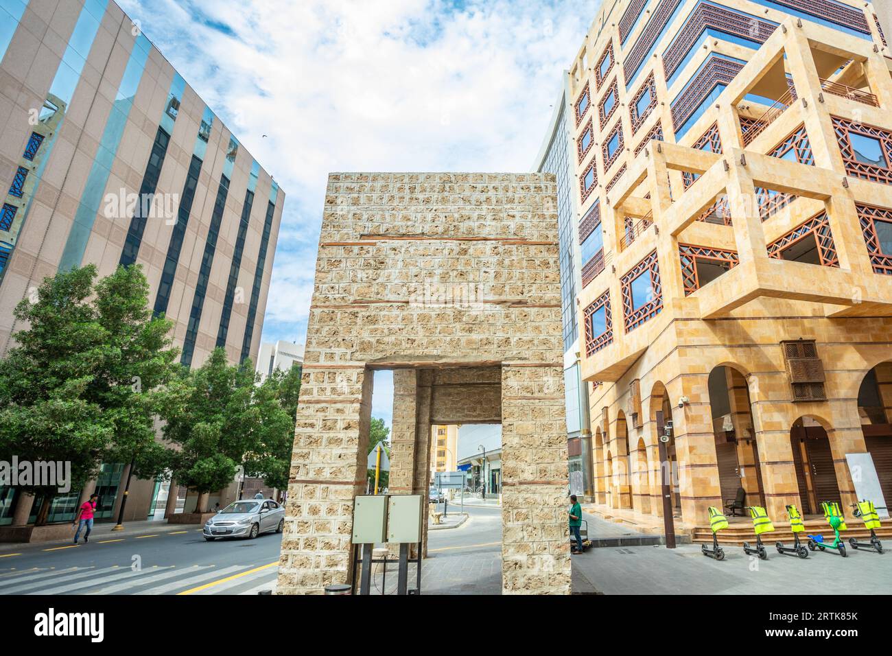 Arch of ancient Bab Alfurdhah Gate surrounded by modern office ...