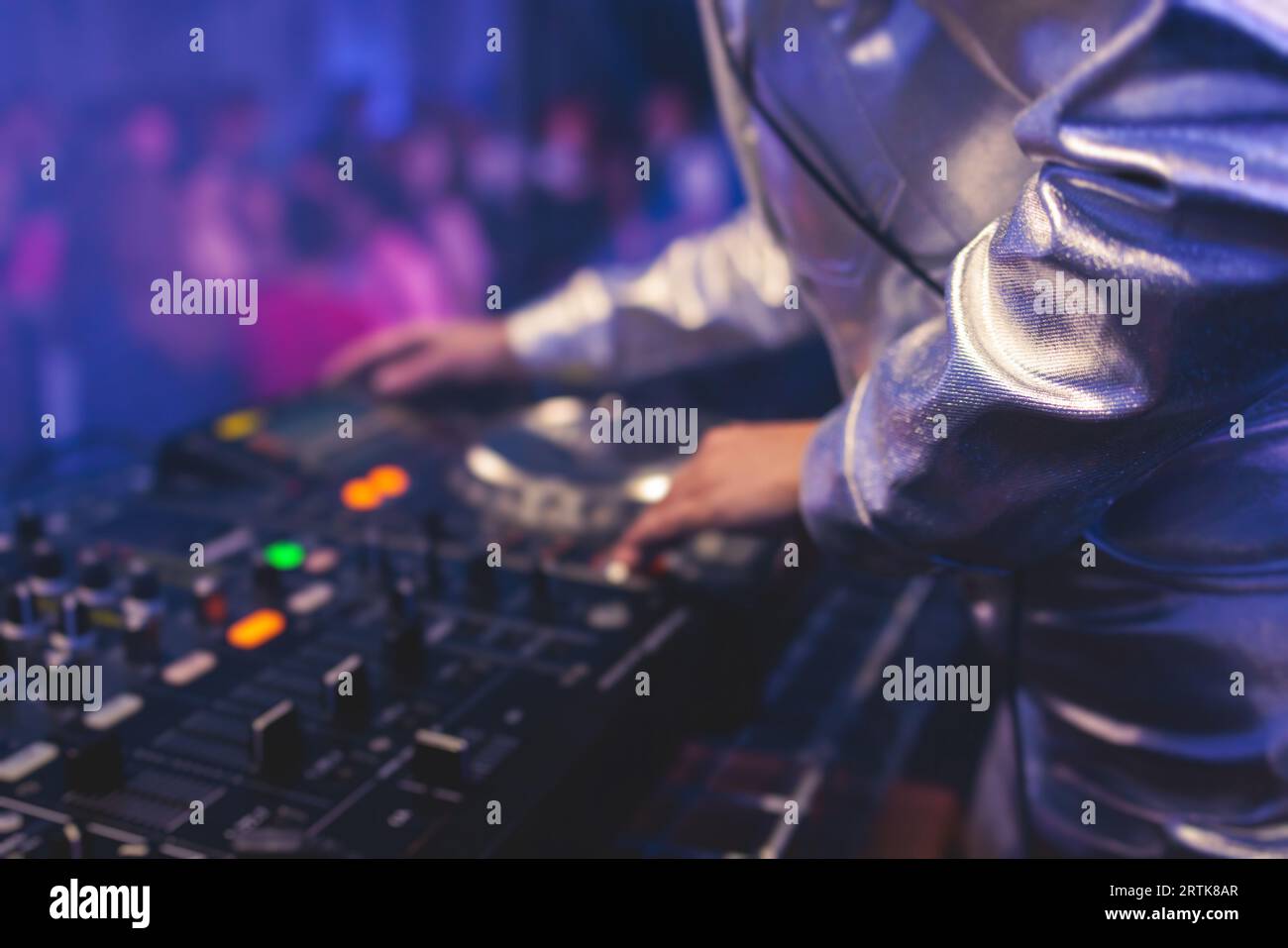 View of Dj mixer and vinyl plate with headphones on a table with female ...