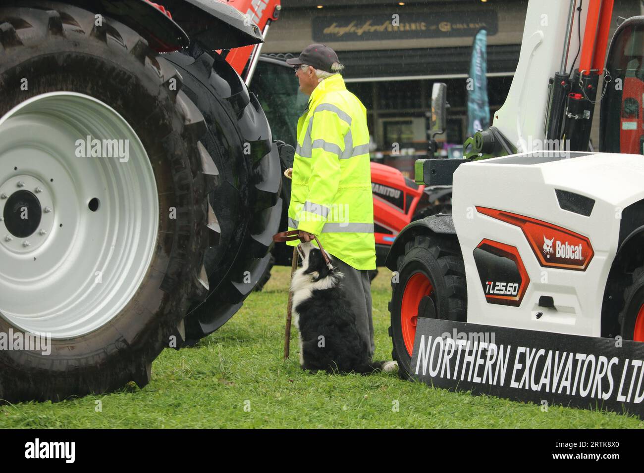 A man and his dog look at some of the machinery on display at the World ...