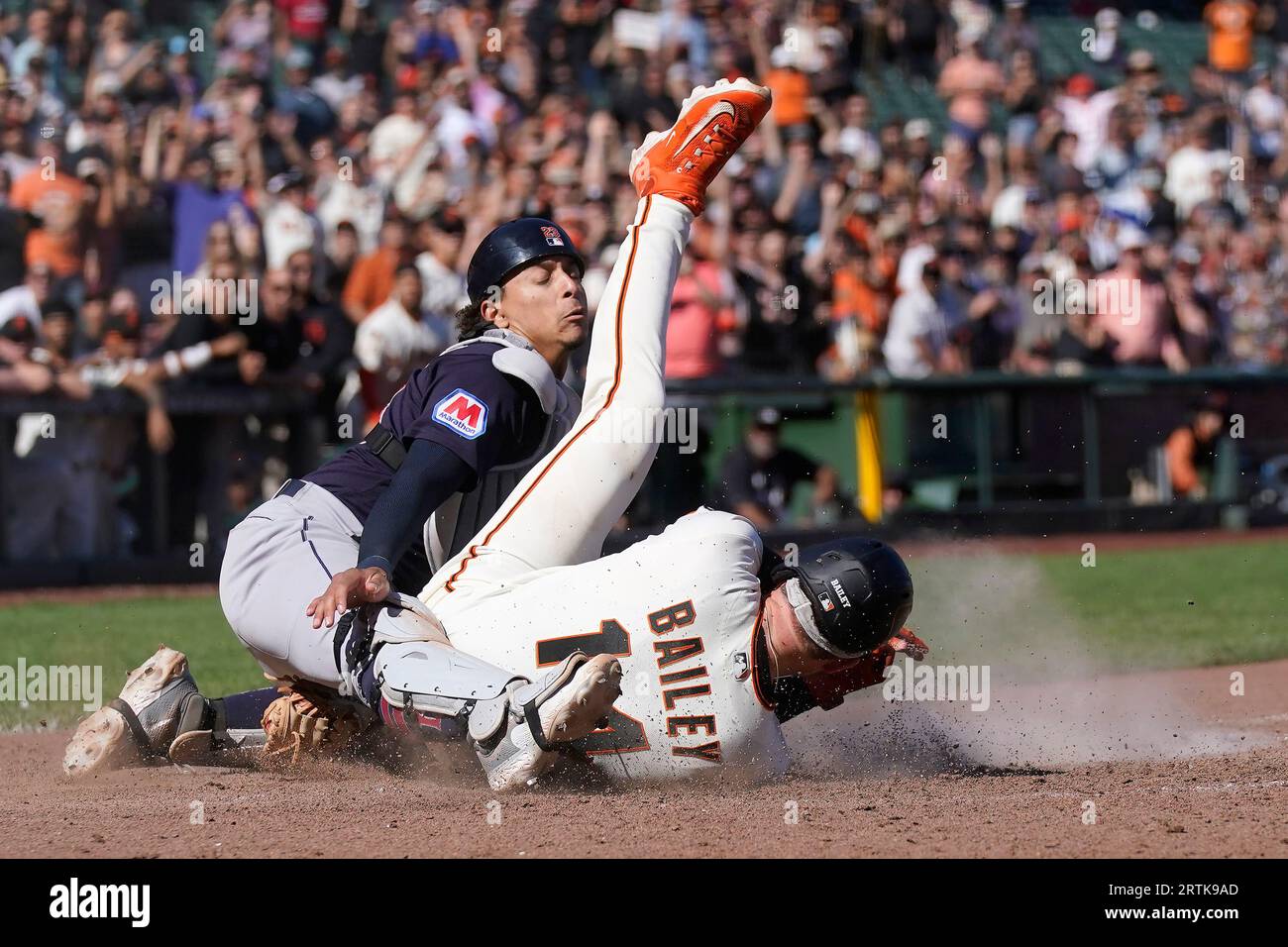 San Francisco Giants' Patrick Bailey, bottom, scores the winning run ...
