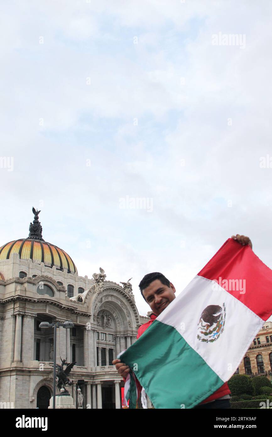 Dark-skinned Latino adult man shows the flag of Mexico proud of his ...