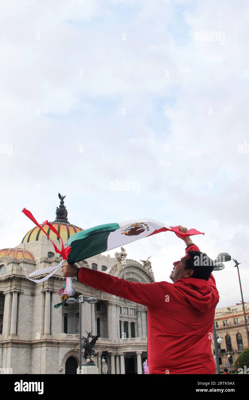 Dark-skinned Latino adult man shows the flag of Mexico proud of his ...