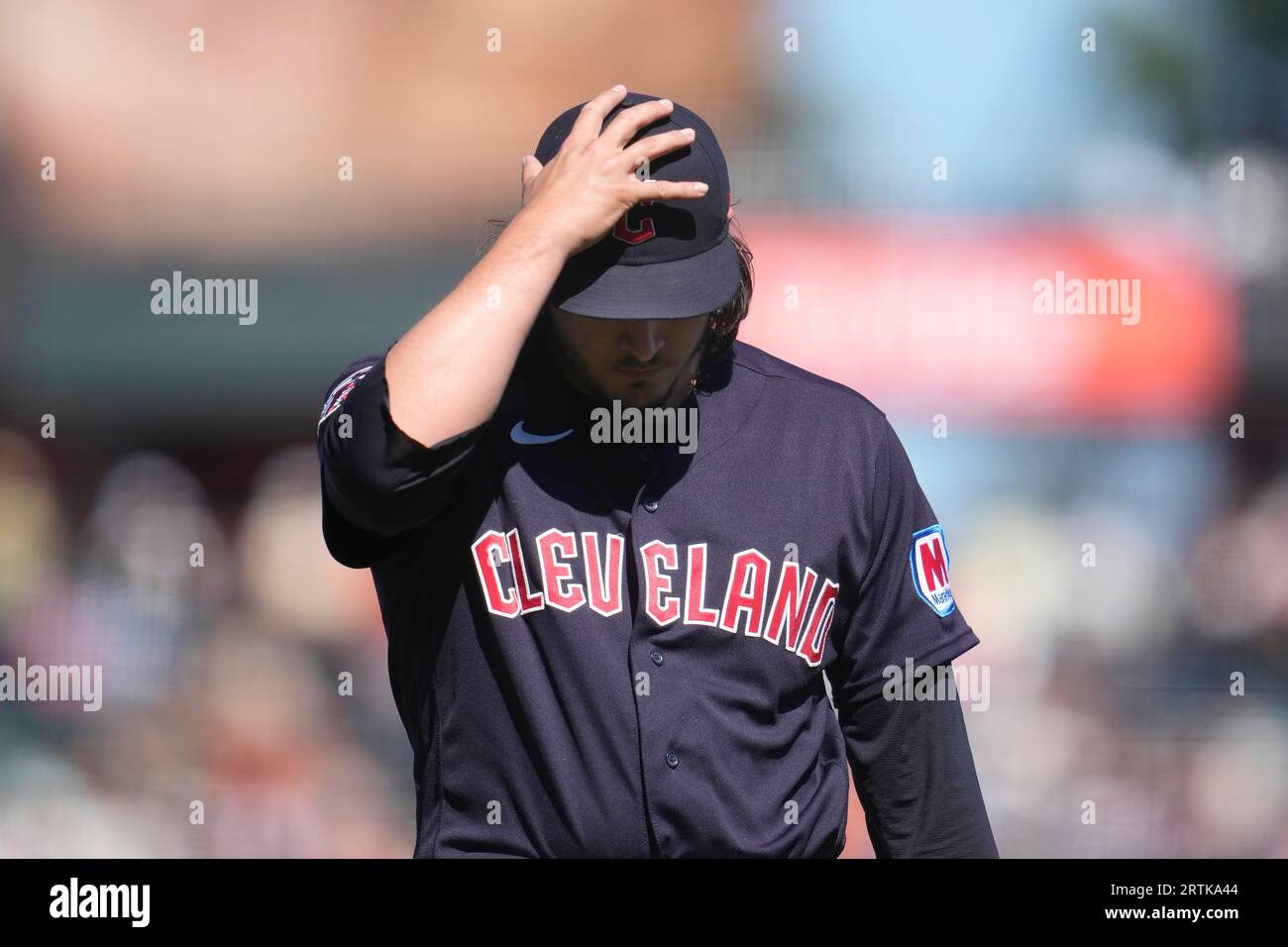 Cleveland Guardians pitcher Eli Morgan walks off the field after being ...