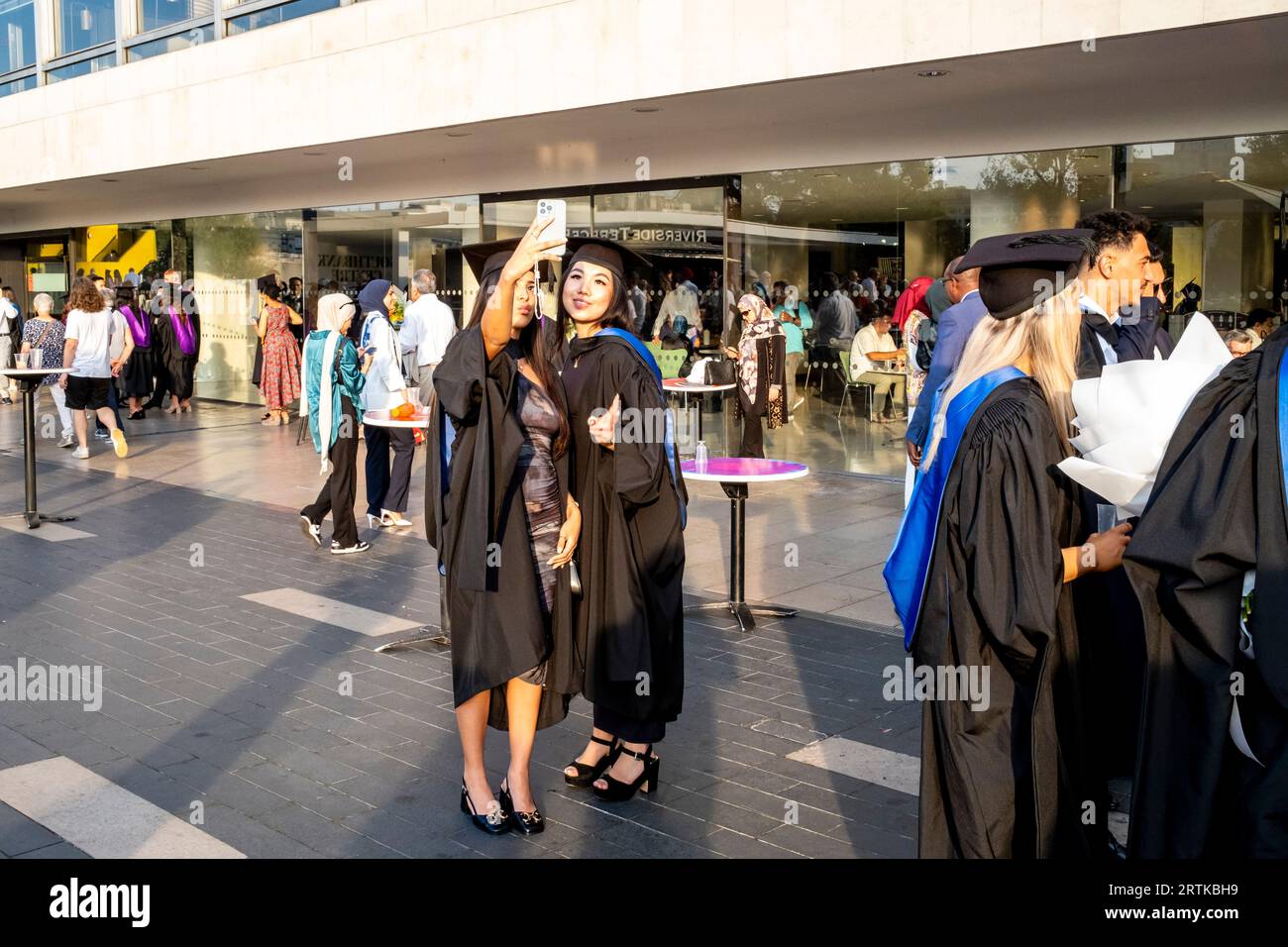 Two Female Degree Students Pose For A Selfie At Their Graduation ...