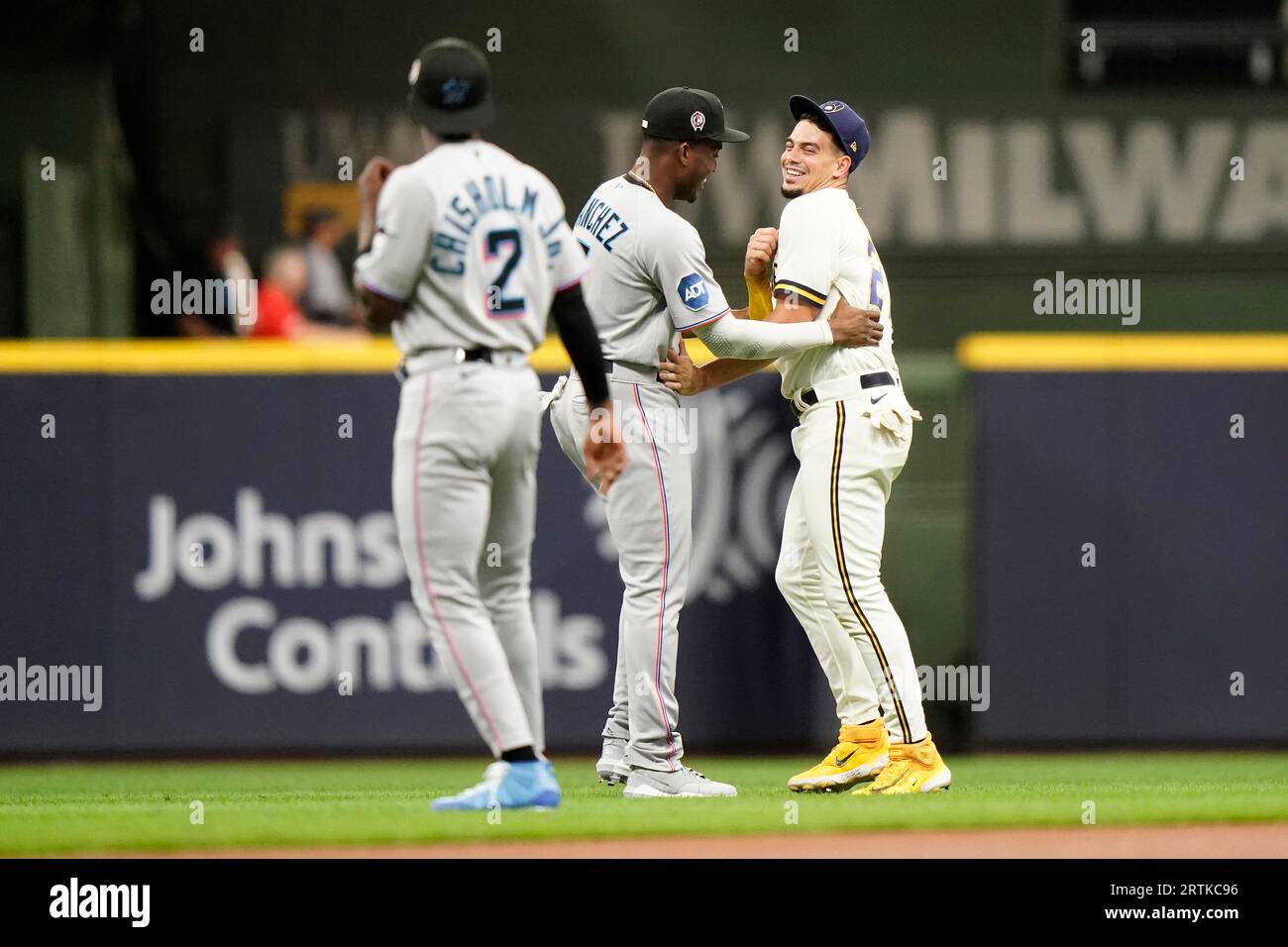 Milwaukee Brewers' Willy Adames laughs with Miami Marlins' Jesus ...