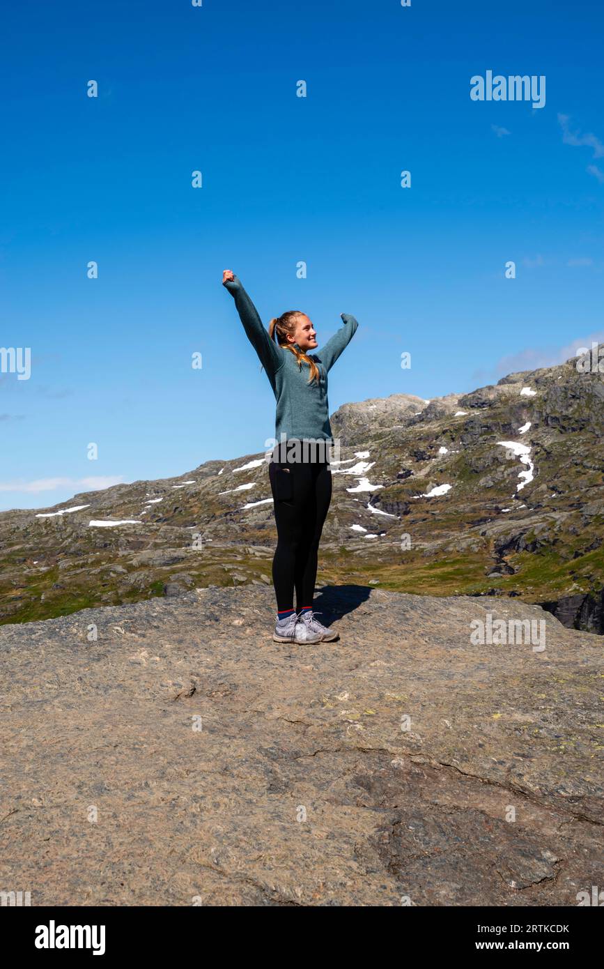 A teenage girl and boy pose on Trolltunga (Troll's Tongue) near ...
