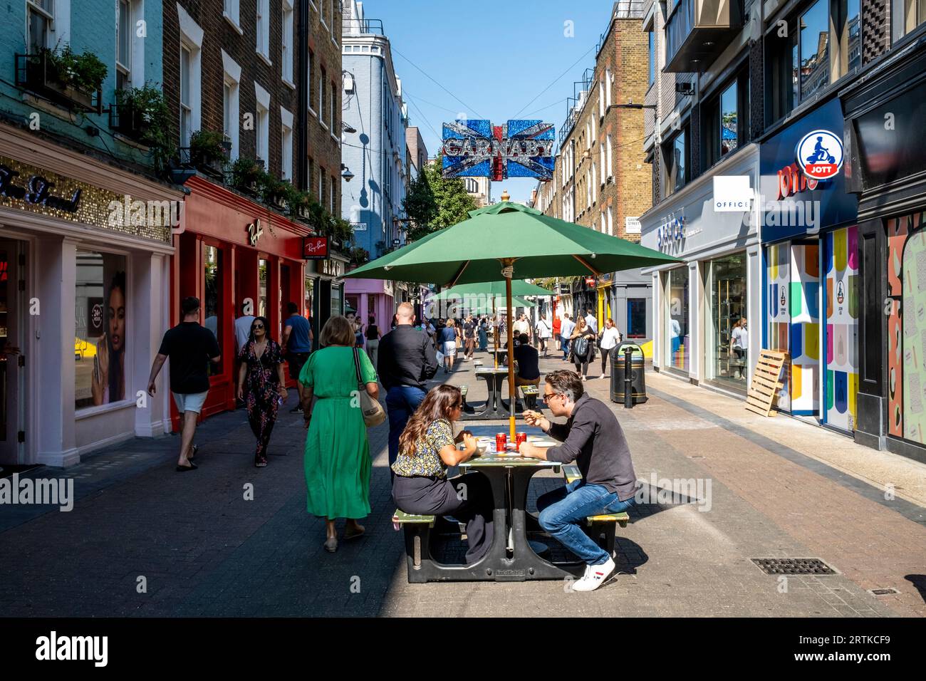 People Sitting Eating At A Cafe In Carnaby Street, Soho, London, UK ...